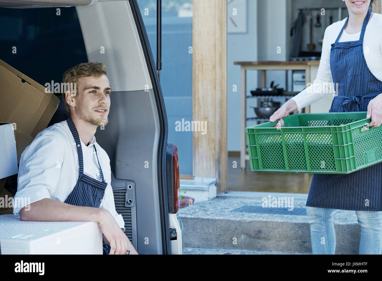 Caterers loading vehicle with prepared food Stock Photo - Alamy