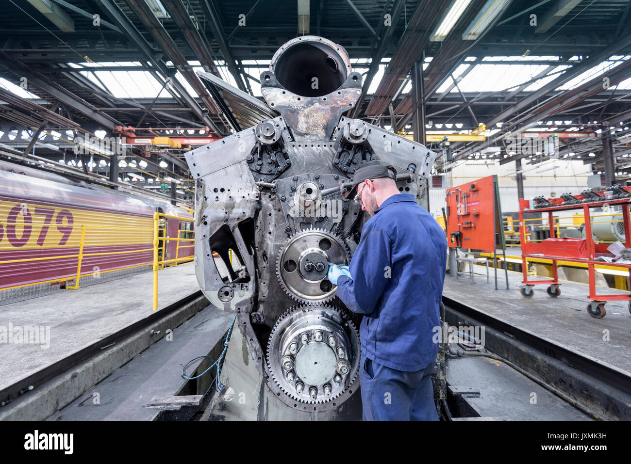 Engineer maintaining locomotive engine in train works Stock Photo - Alamy