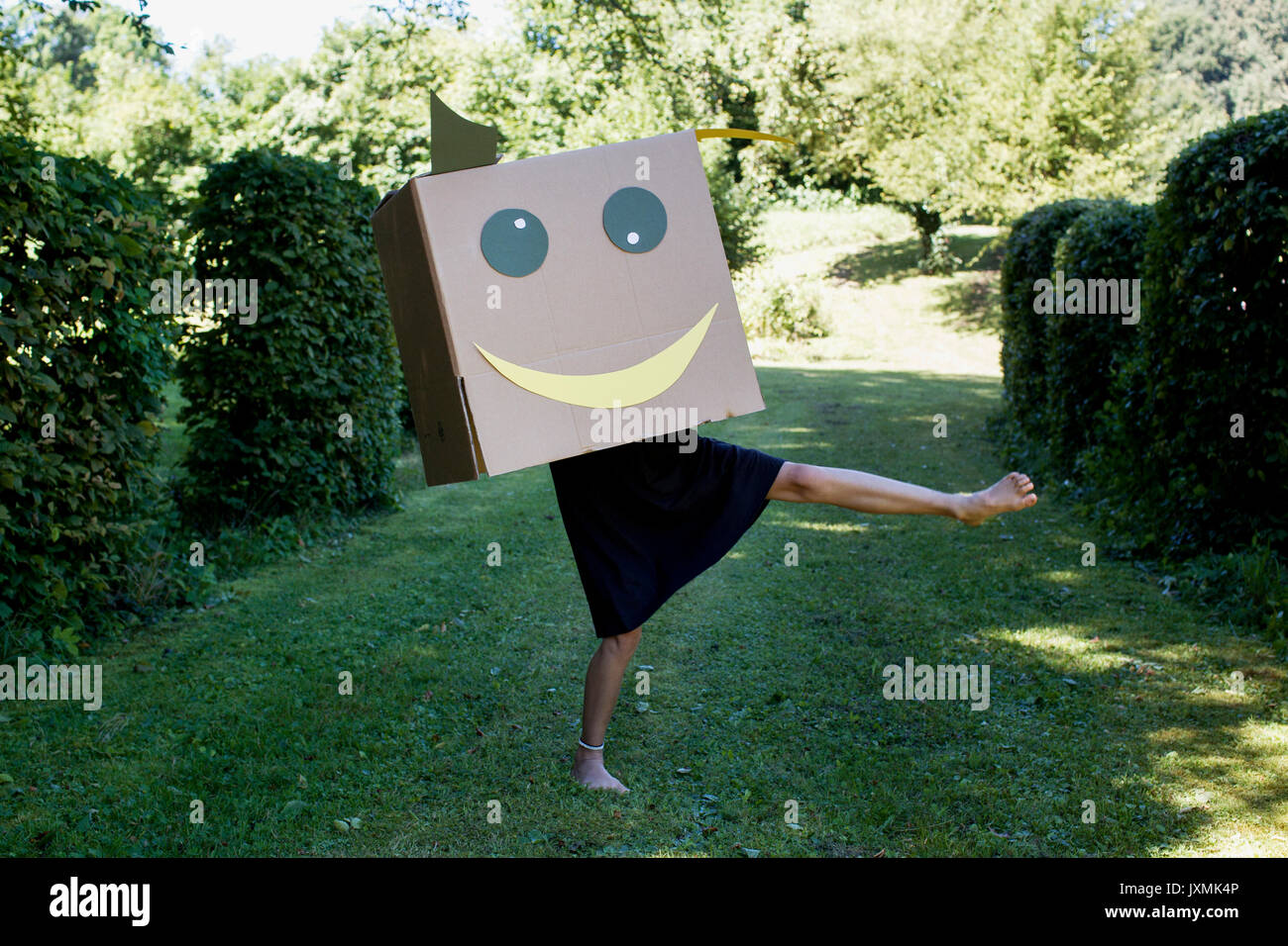 Girl with smiley face box over head Stock Photo - Alamy