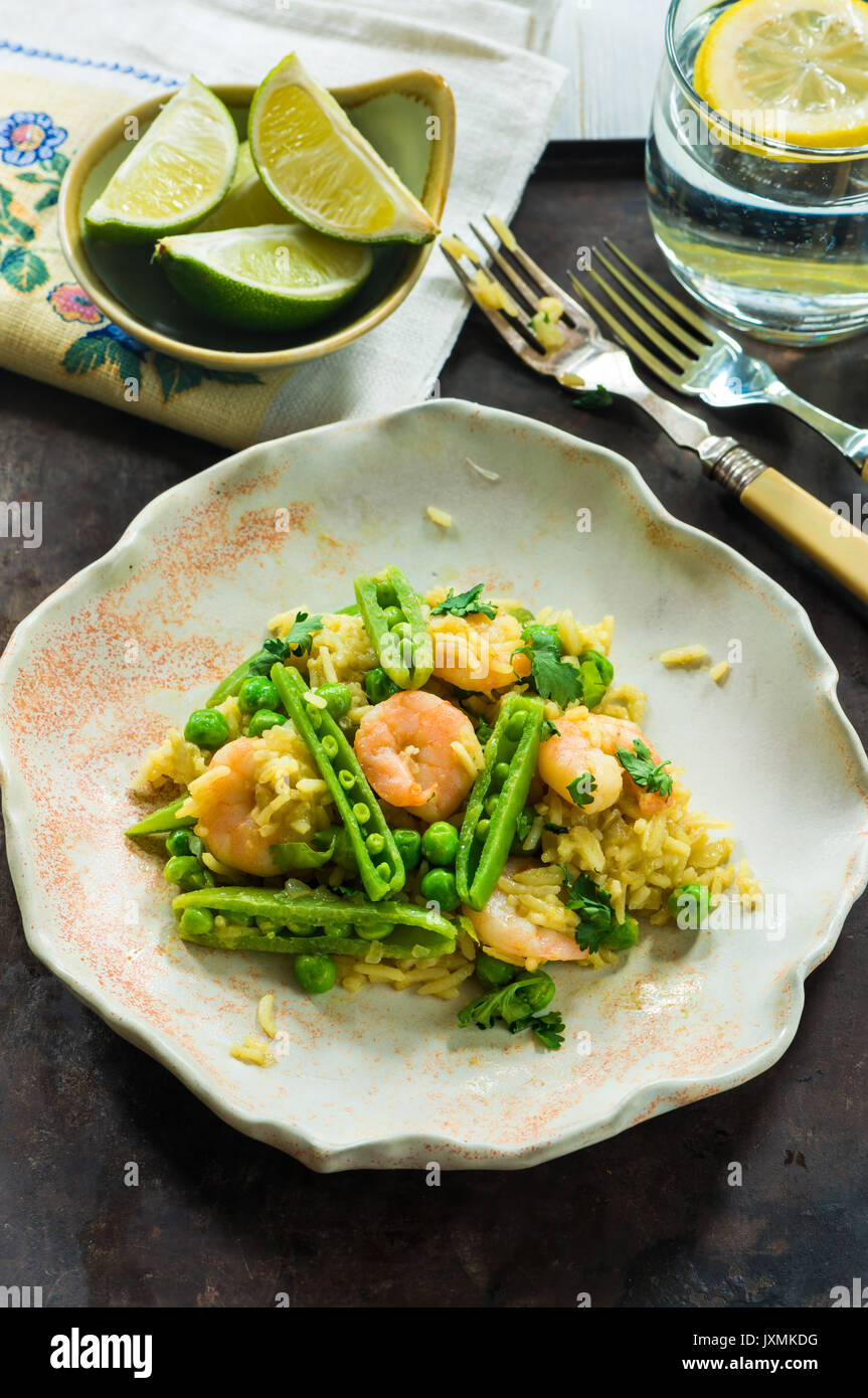 Thai prawn and pea pilaf garnished with a slice of lime Stock Photo - Alamy