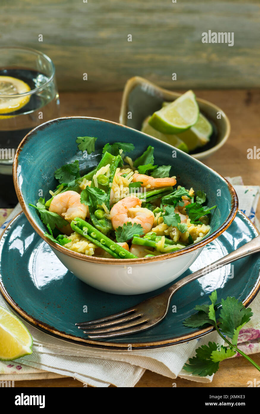 Thai prawn and pea pilaf garnished with a slice of lime Stock Photo - Alamy