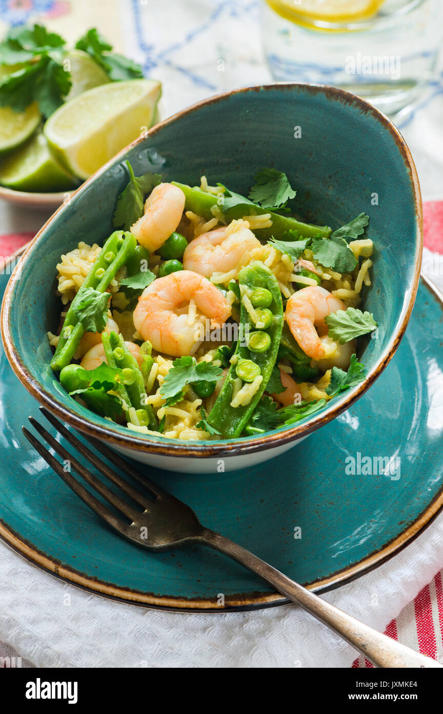Thai prawn and pea pilaf garnished with a slice of lime Stock Photo - Alamy