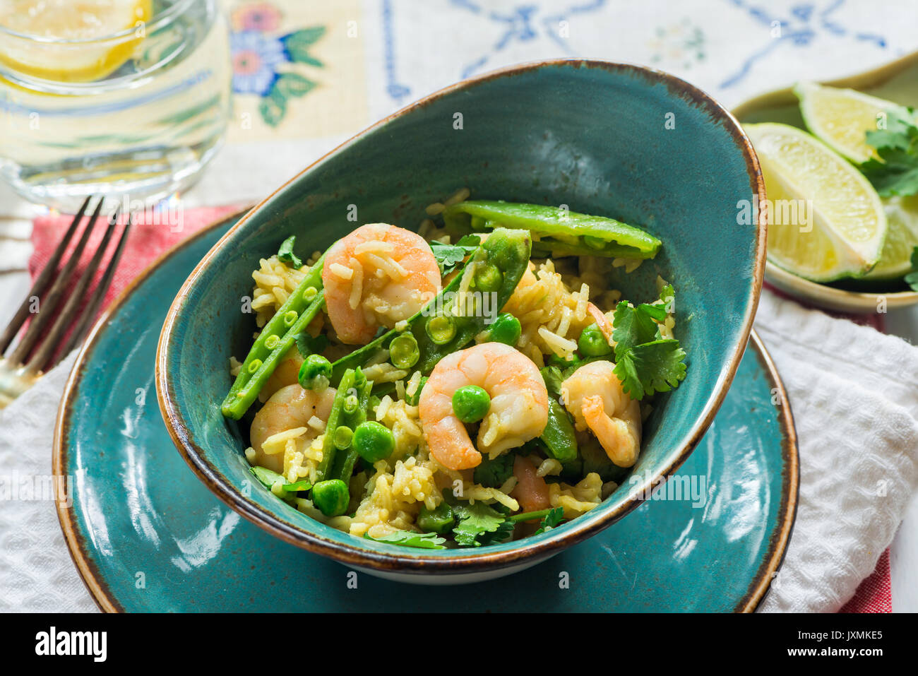 Thai prawn and pea pilaf garnished with a slice of lime Stock Photo - Alamy
