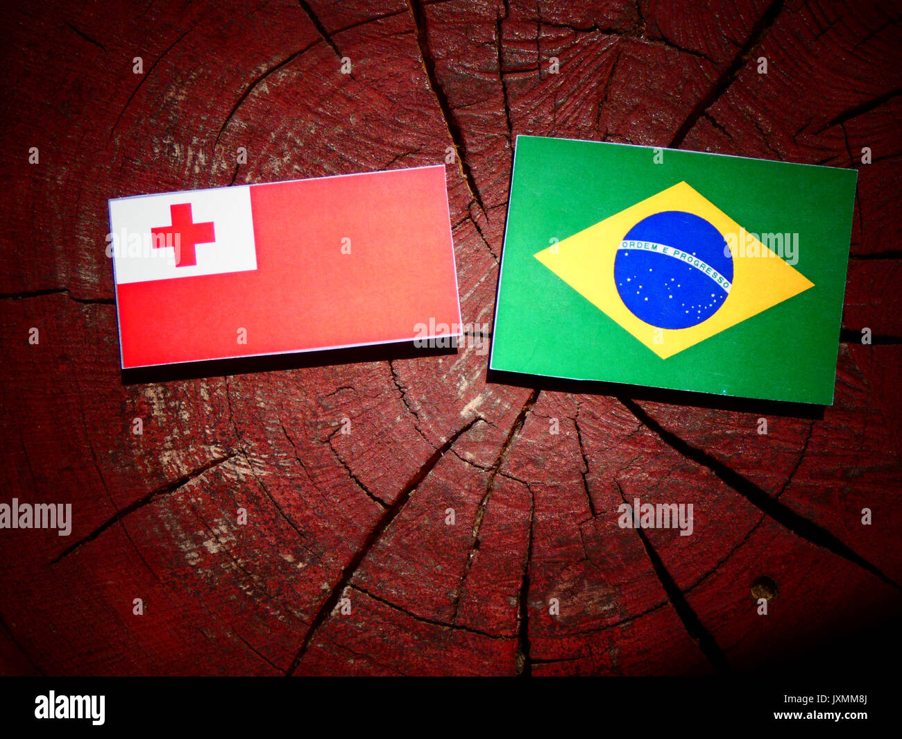 Tonga flag with Brazilian flag on a tree stump isolated Stock Photo - Alamy
