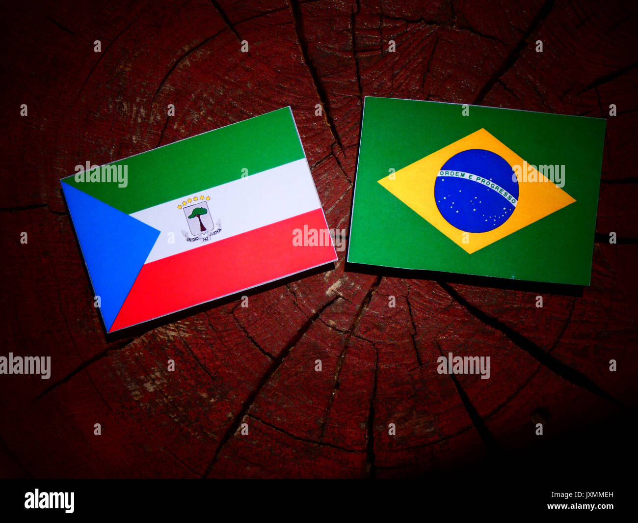 Equatorial Guinea flag with Brazilian flag on a tree stump isolated ...