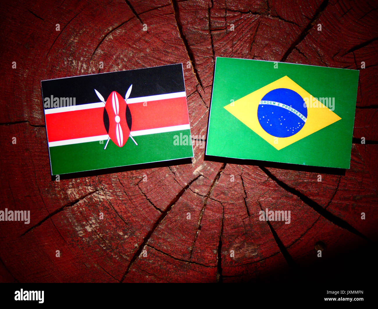 Kenyan flag with Brazilian flag on a tree stump isolated Stock Photo ...
