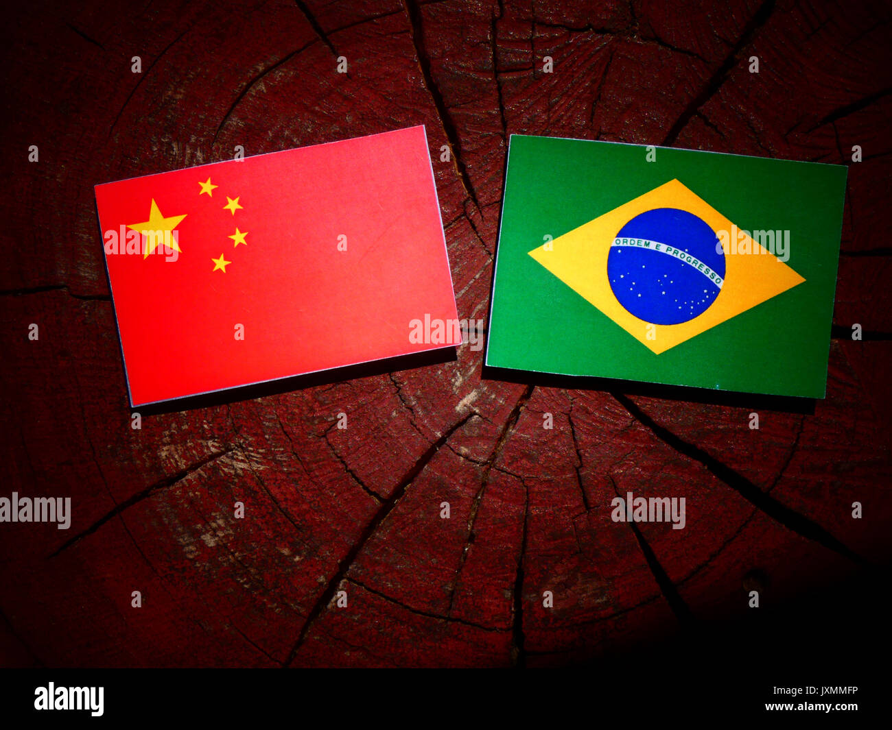 Chinese flag with Brazilian flag on a tree stump isolated Stock Photo ...