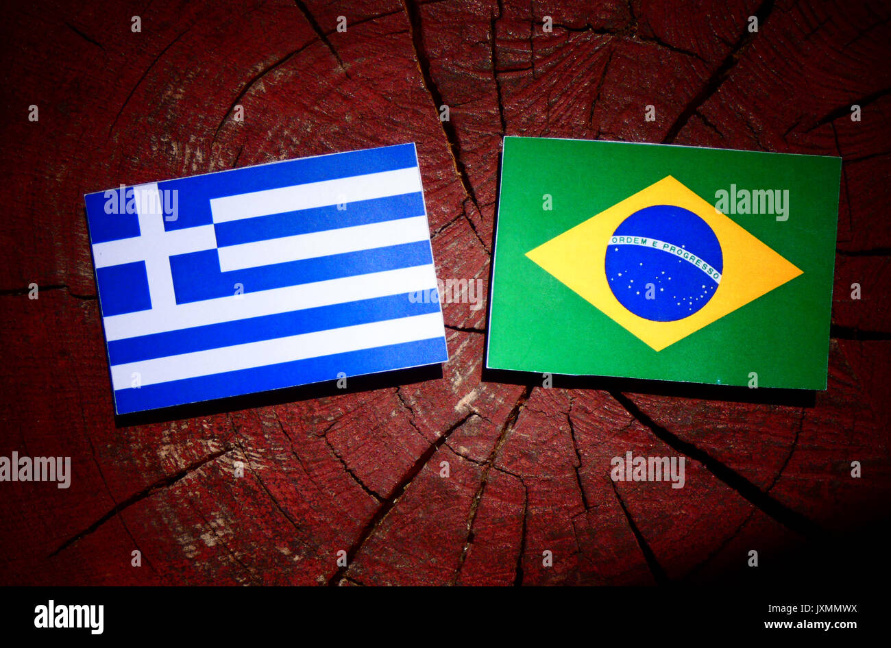 Greek flag with Brazilian flag on a tree stump isolated Stock Photo - Alamy