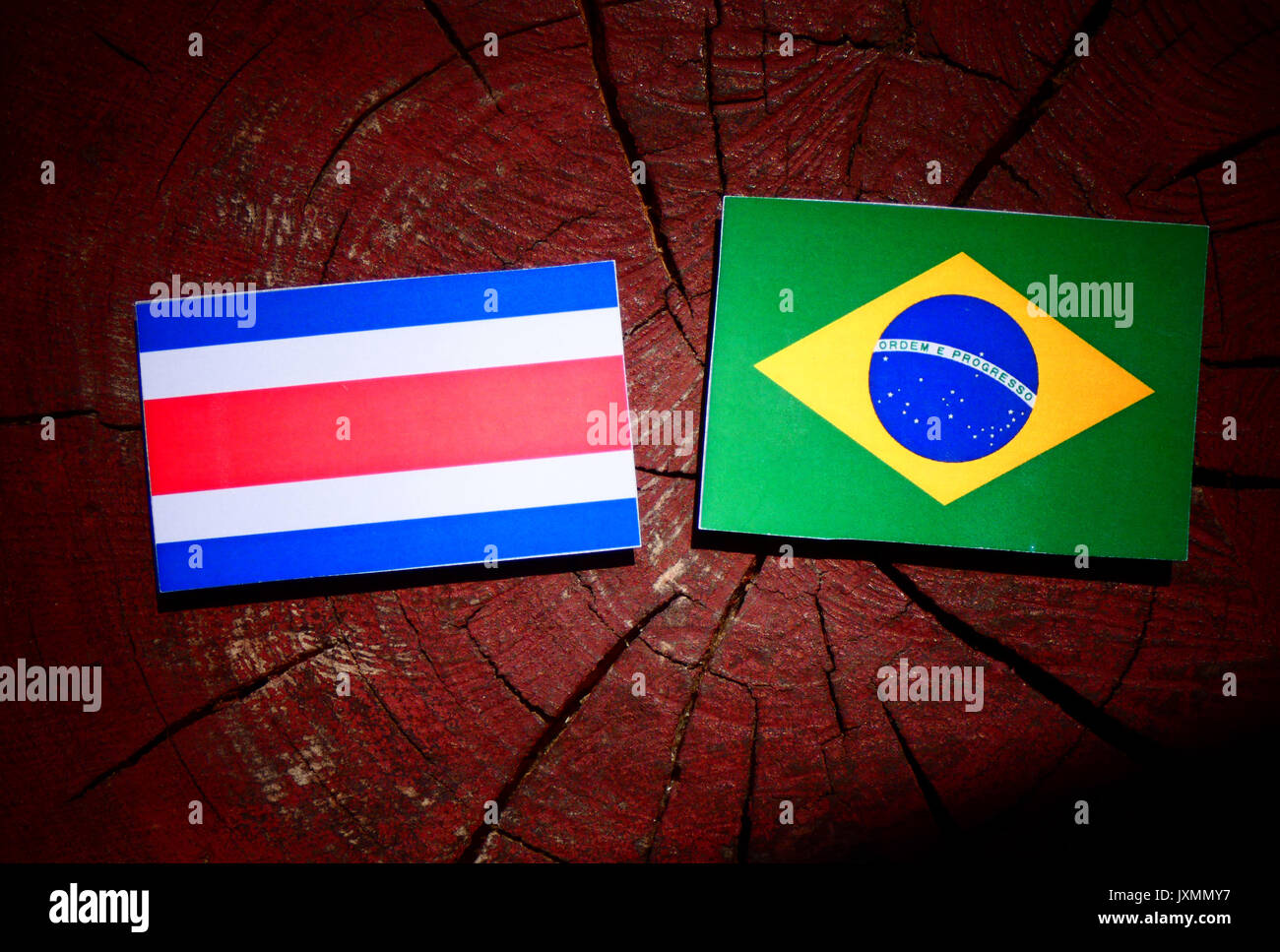 Costa Rican flag with Brazilian flag on a tree stump isolated Stock ...