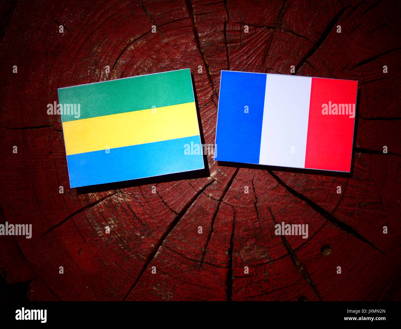 Gabon flag with French flag on a tree stump isolated Stock Photo - Alamy
