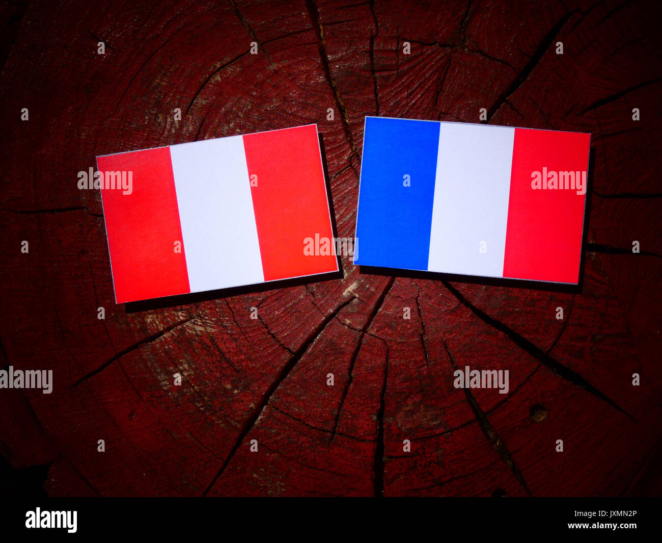 Peruvian flag with French flag on a tree stump isolated Stock Photo - Alamy