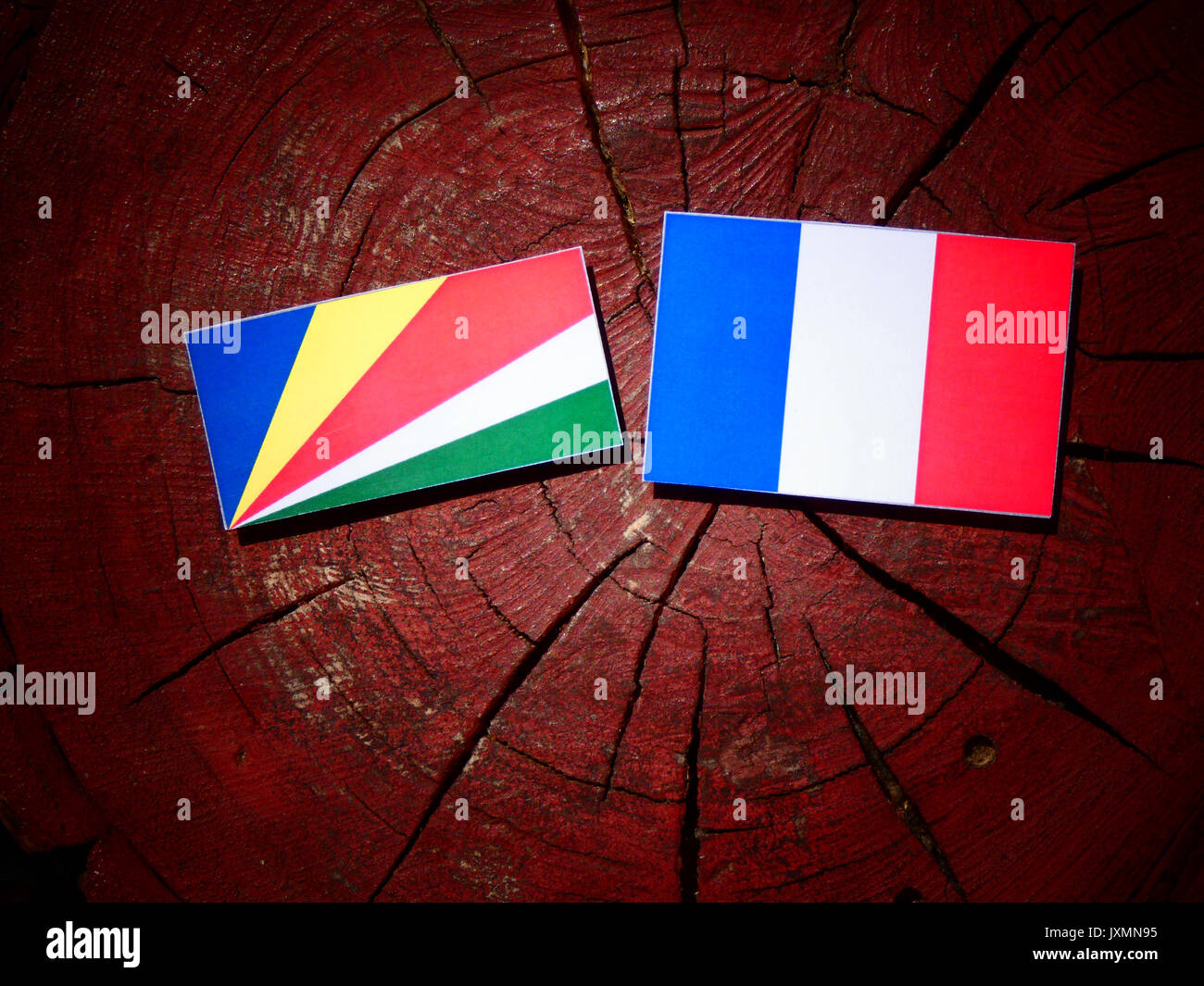 Seychelles flag with French flag on a tree stump isolated Stock Photo ...