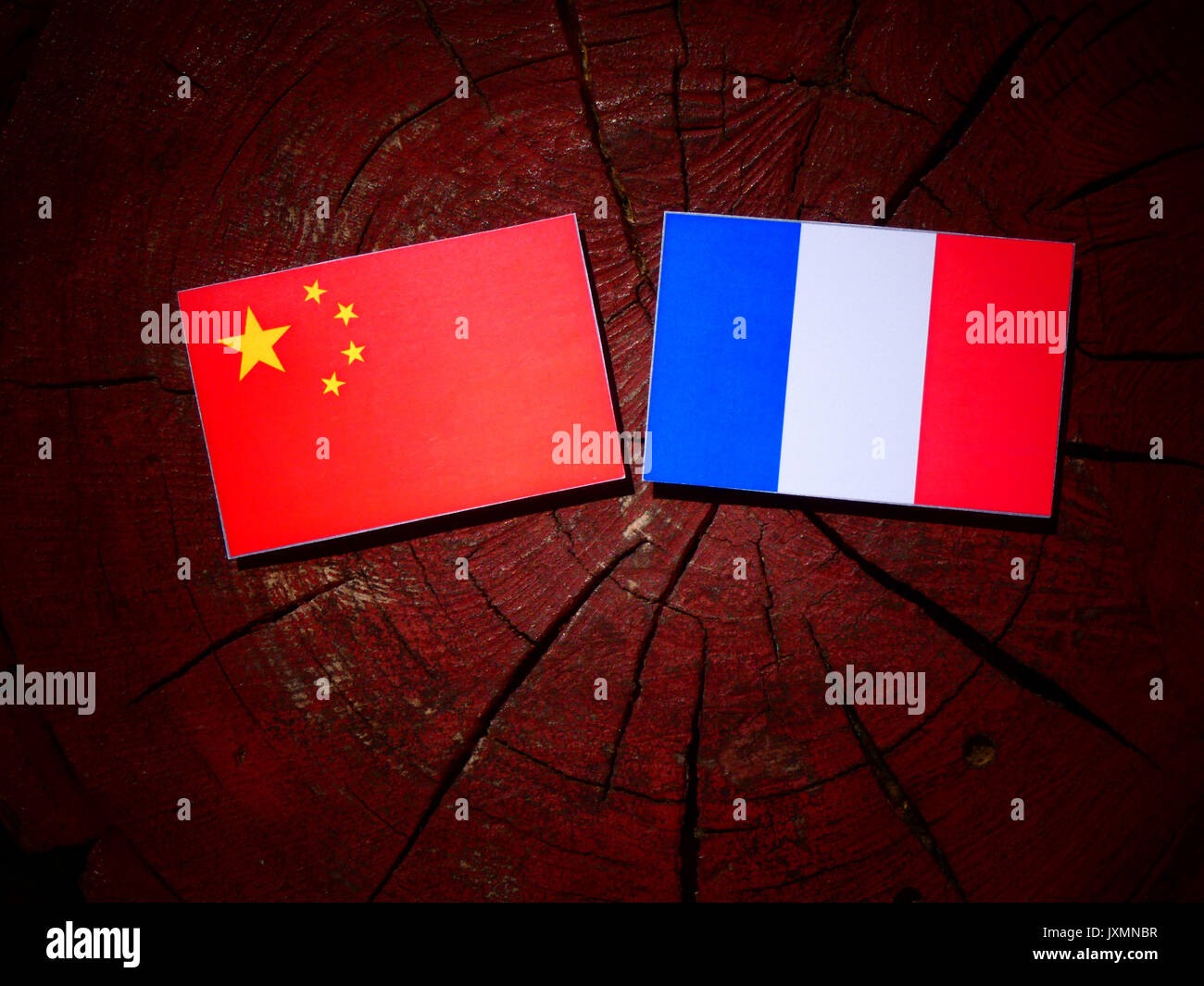 Chinese flag with French flag on a tree stump isolated Stock Photo - Alamy