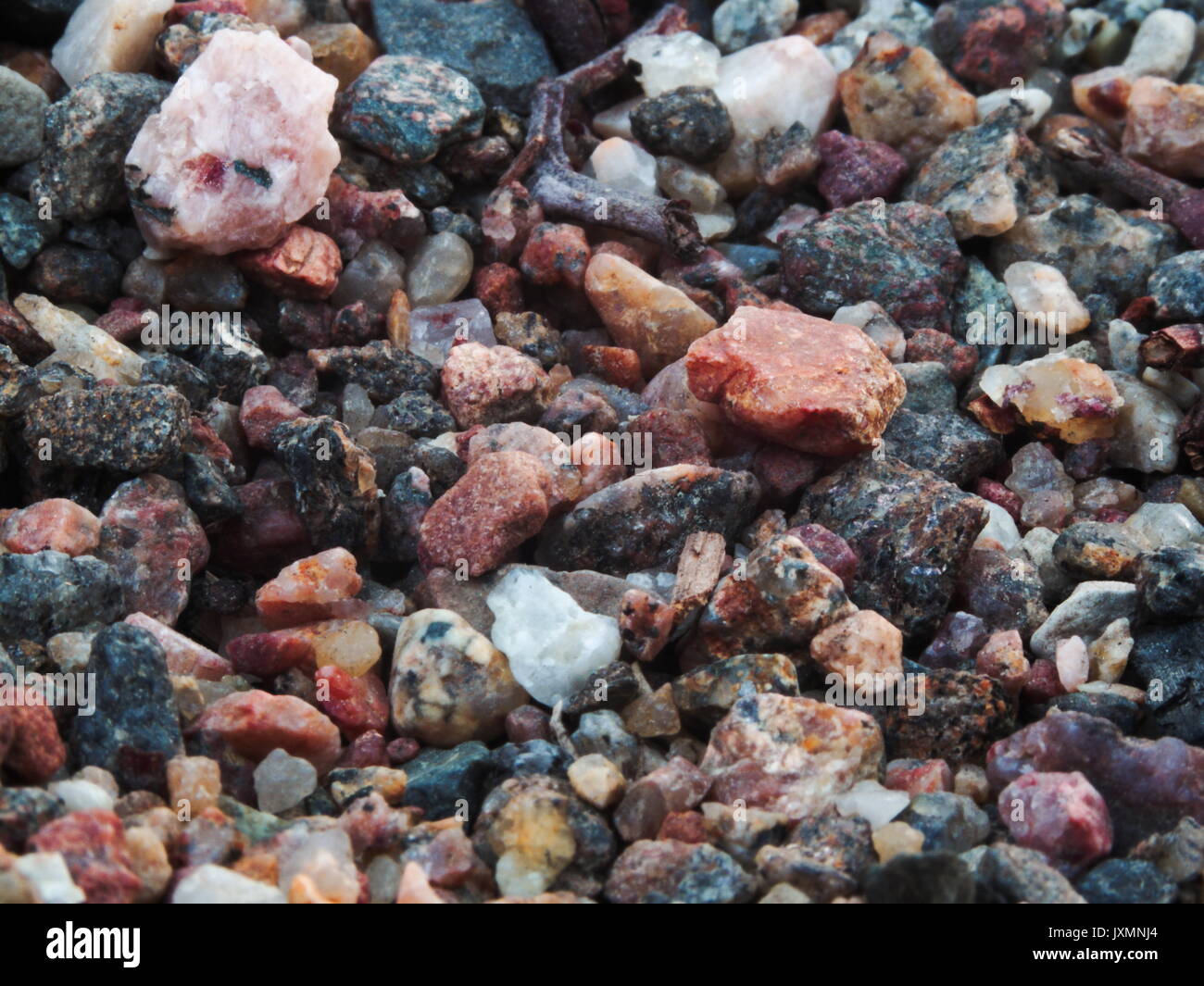 Rough edged pebbles on a beach colourful Stock Photo - Alamy
