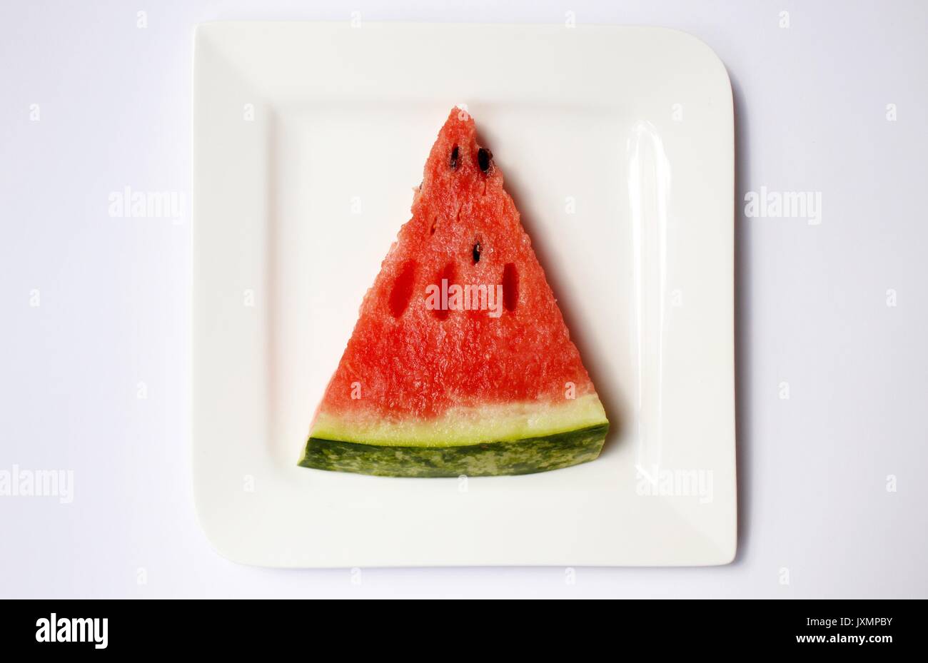 Watermelon slice on white plate Stock Photo - Alamy