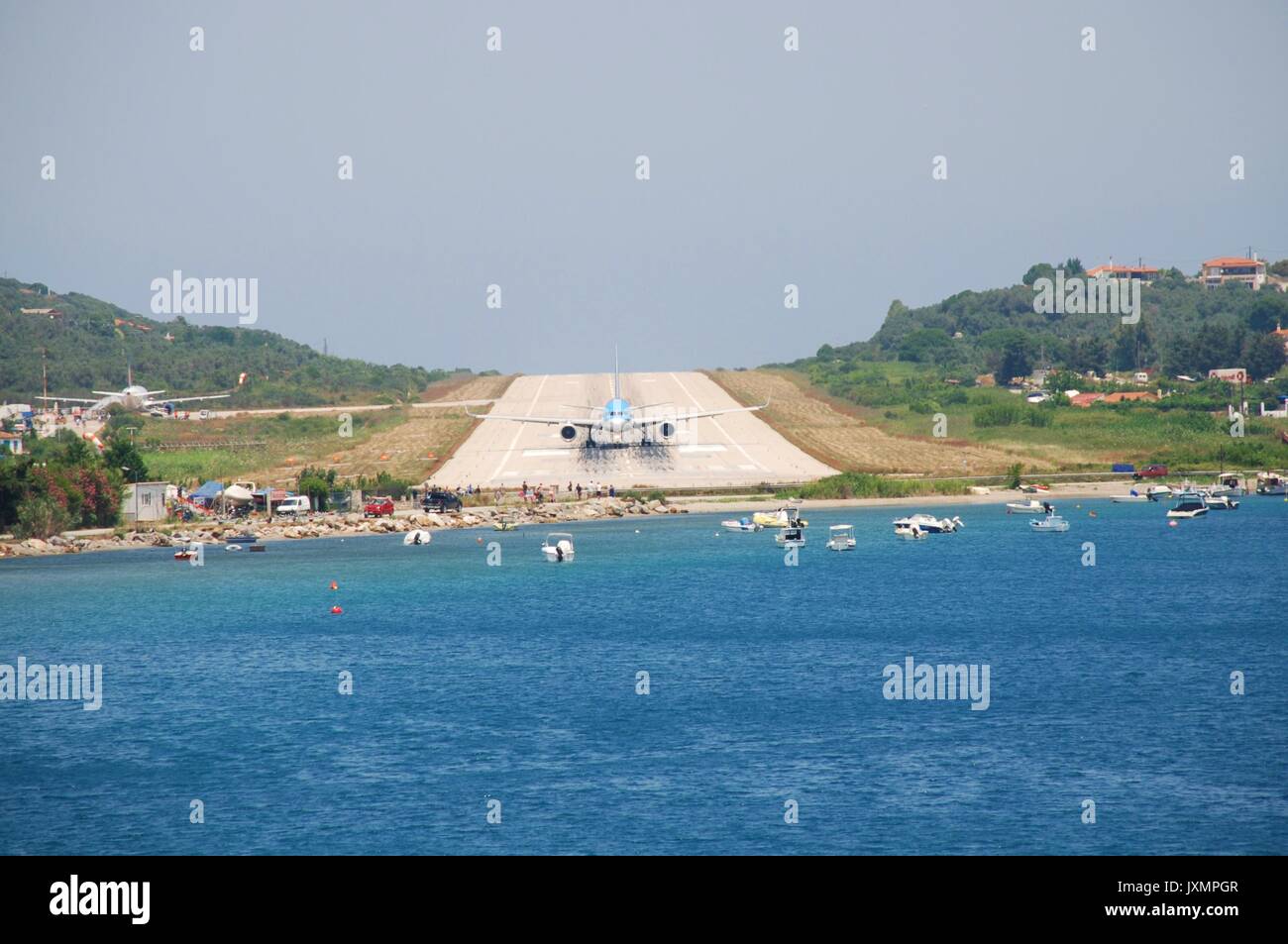 An airliner taxis on the runway at the airport on the Greek island of ...