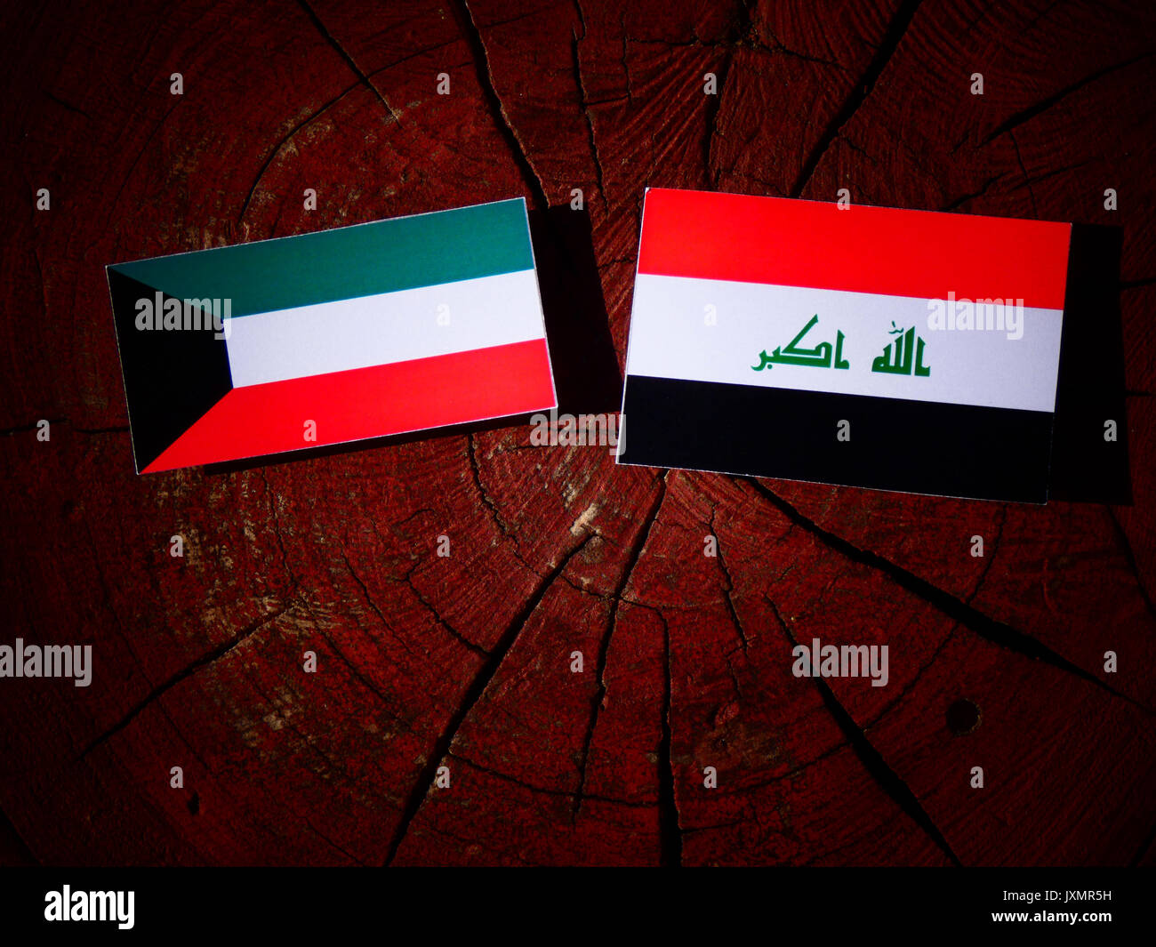 Kuwaiti flag with Iraqi flag on a tree stump isolated Stock Photo - Alamy