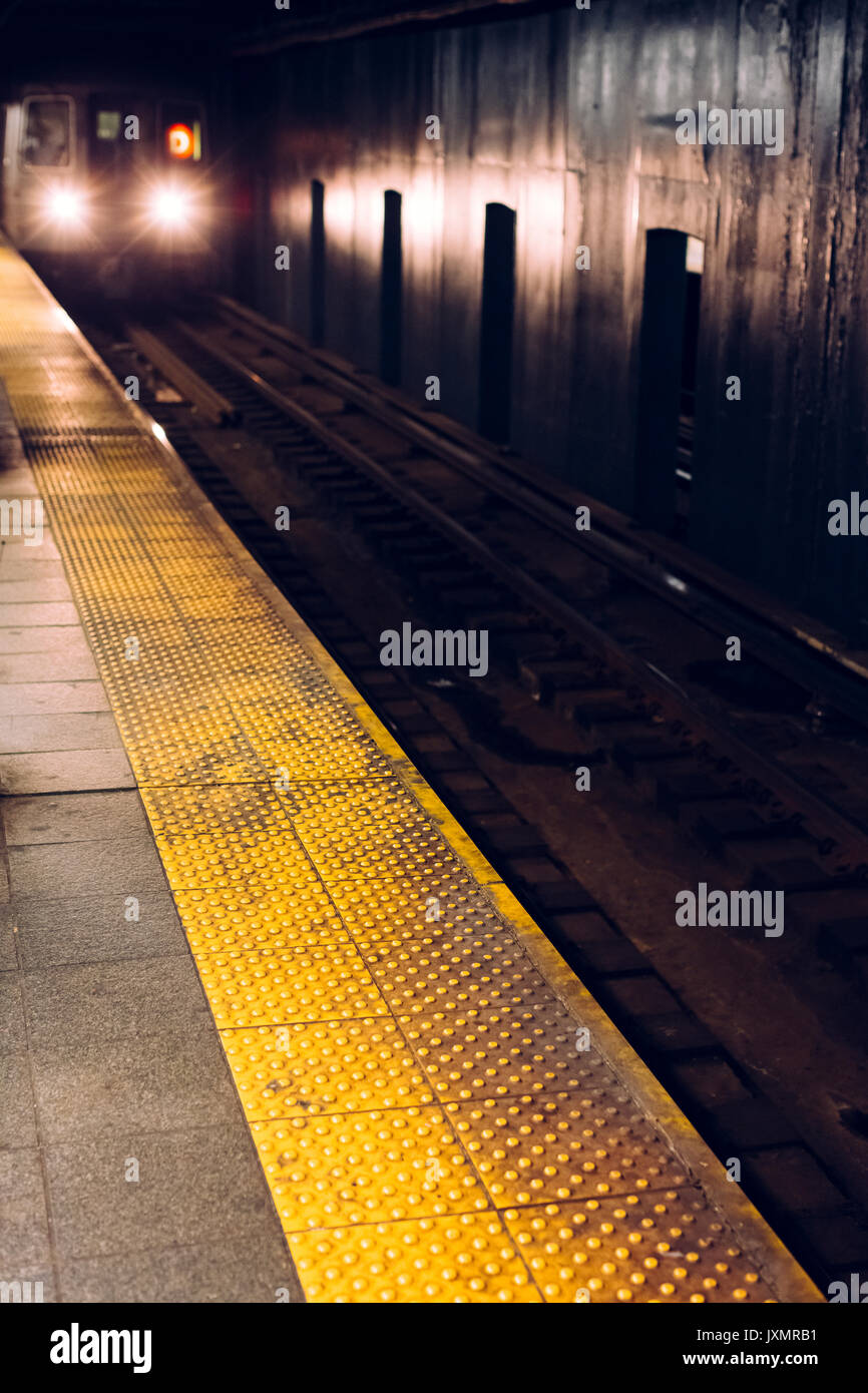 Subway train with headlights arriving at subway platform, Times Square ...