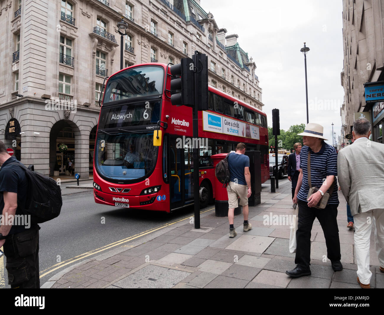 A London street scene in Piccadilly with a red London bus opposite the ...