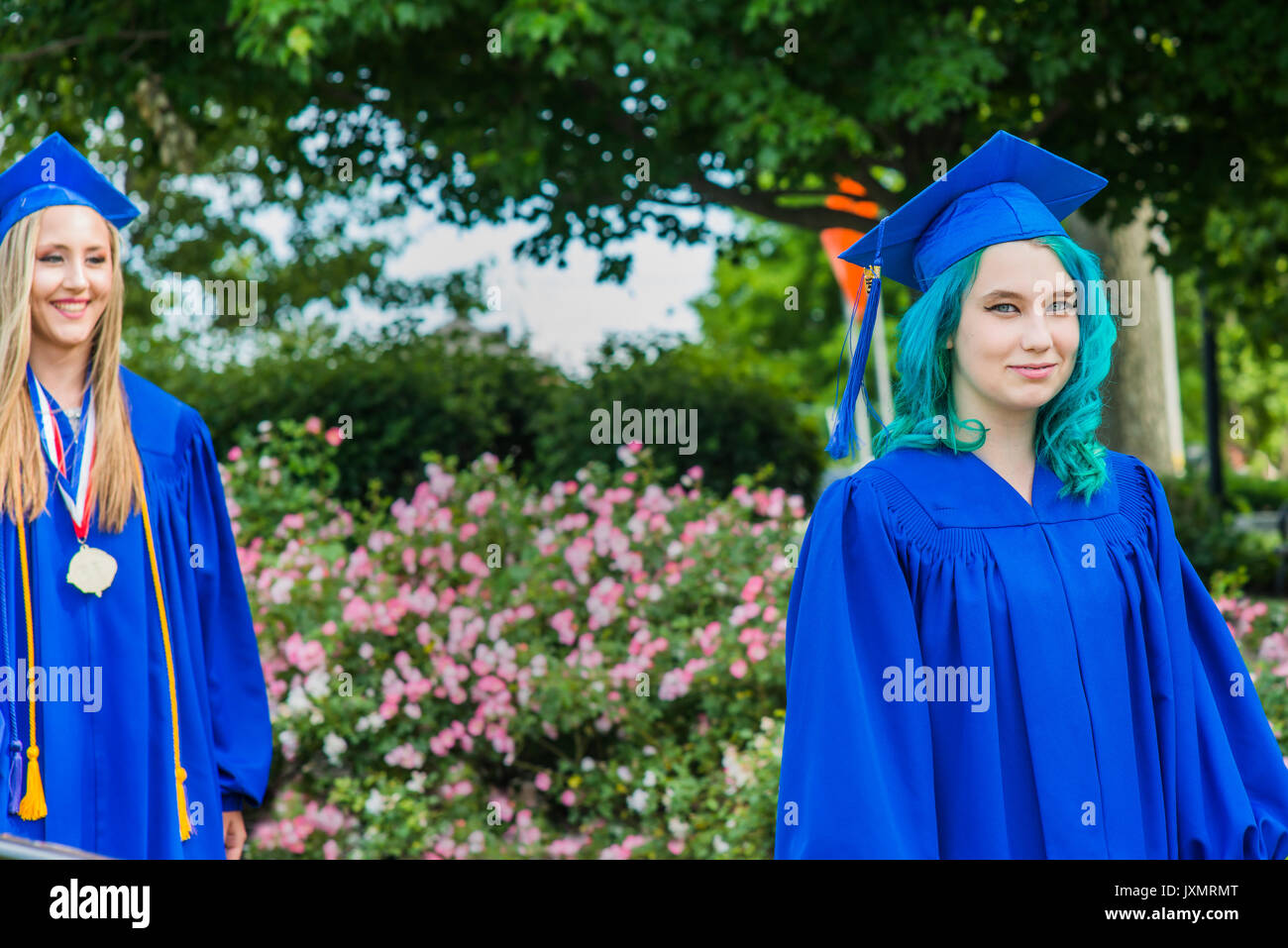 Two female students in graduation gowns Stock Photo - Alamy