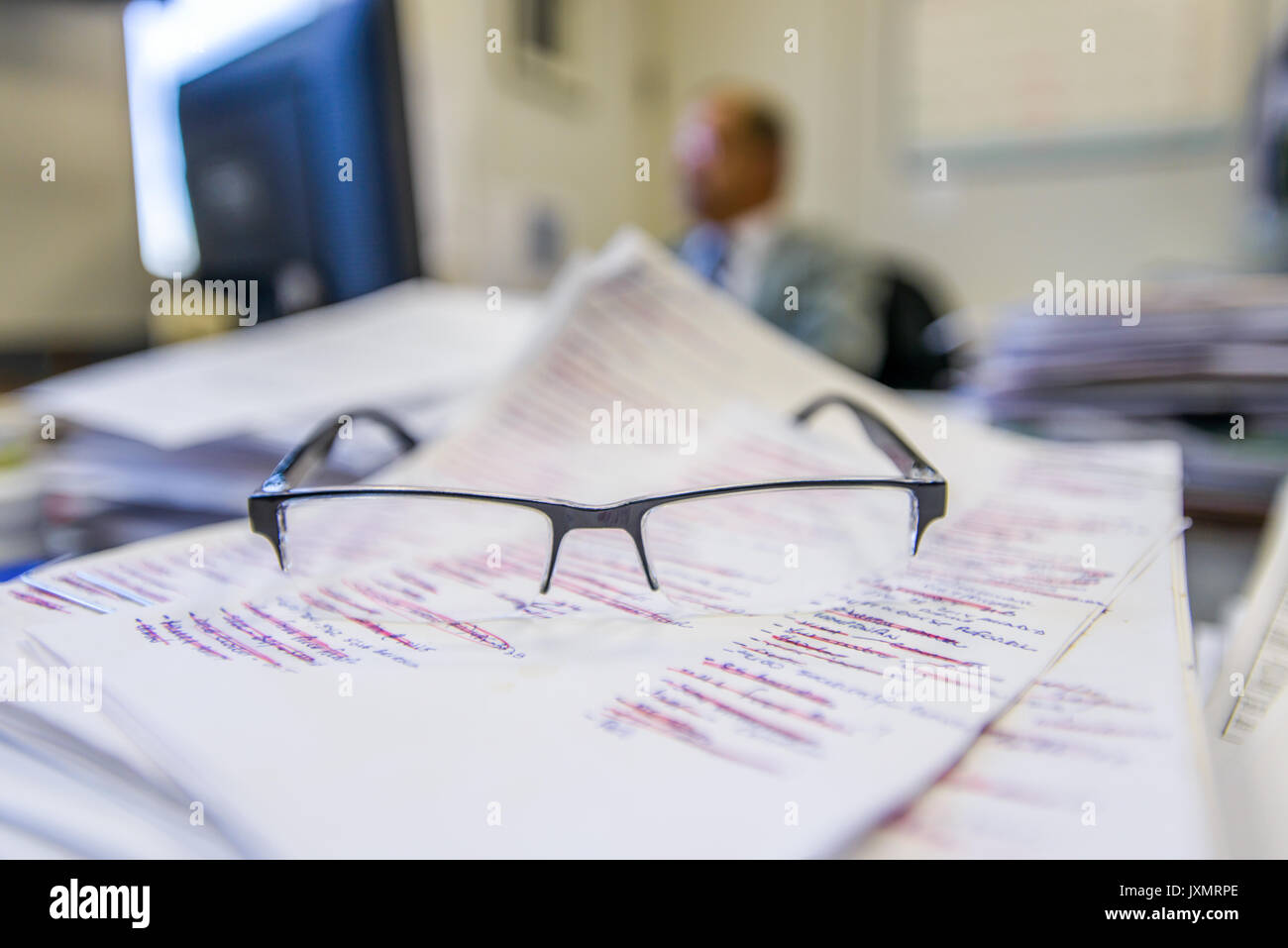 Pair of glasses on paperwork in office, close up Stock Photo - Alamy