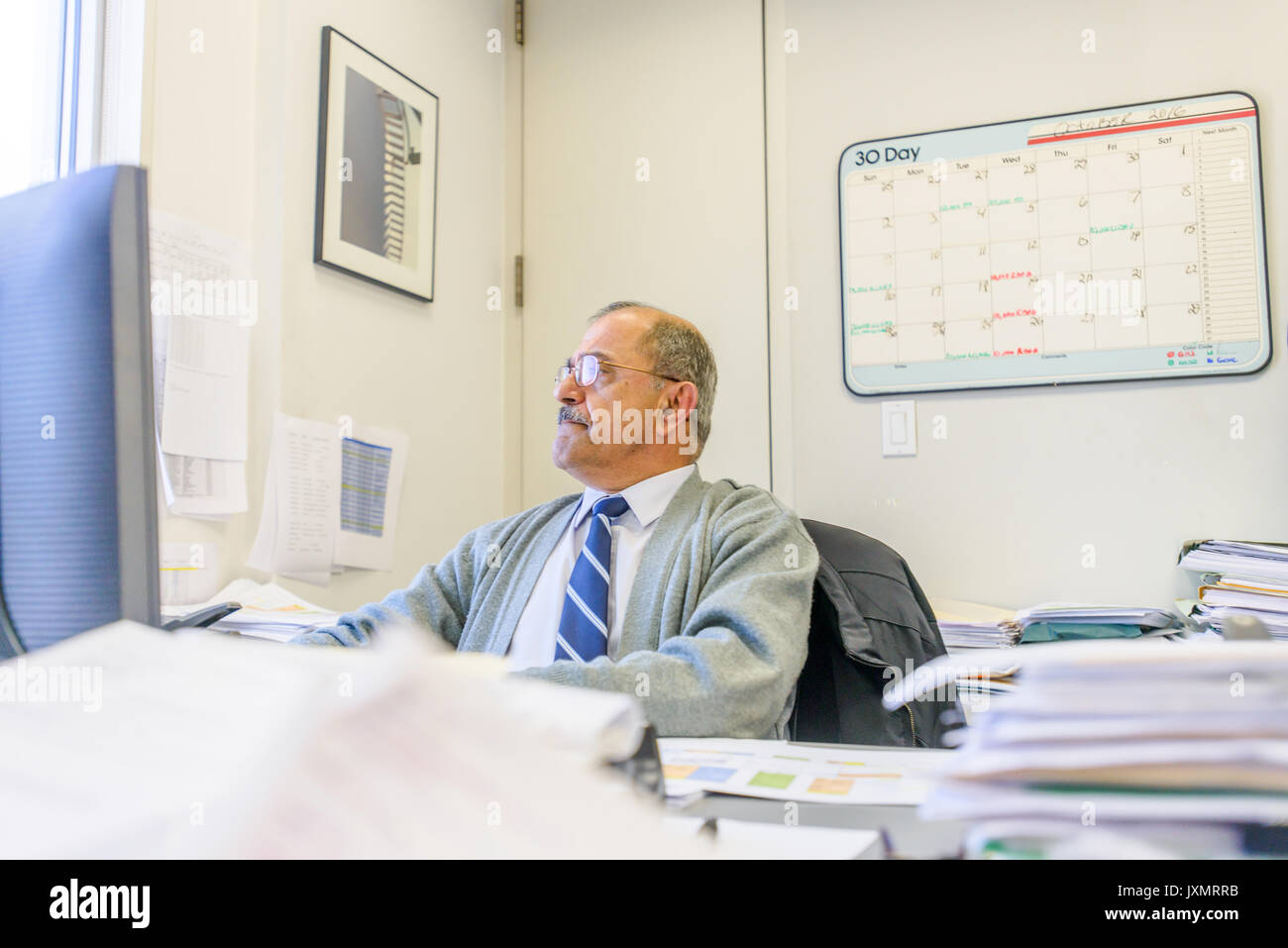 Male office worker using desktop computer at office desk Stock Photo ...