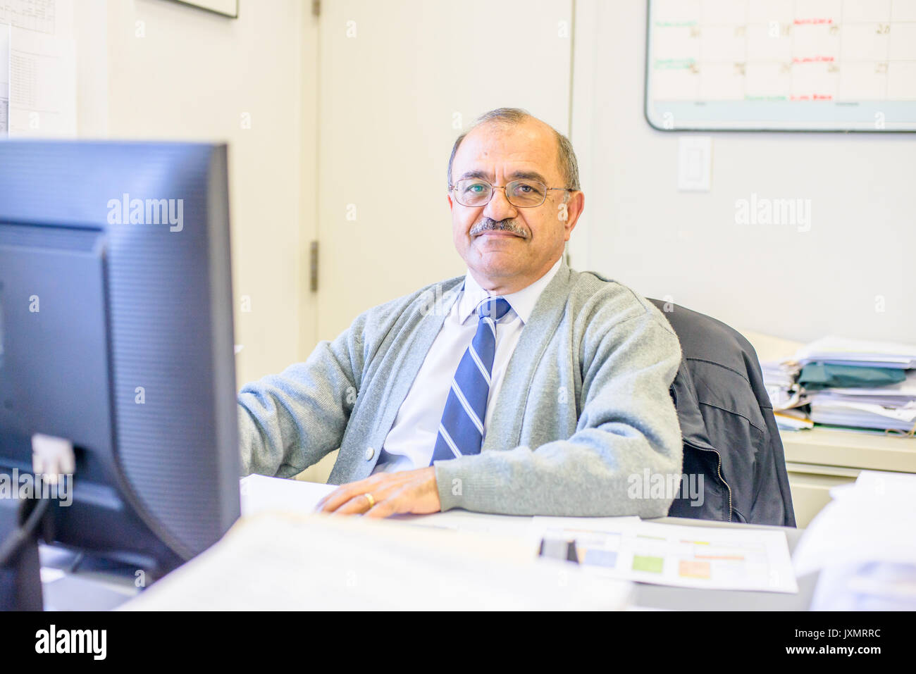 Portrait of senior male office worker at office desk Stock Photo - Alamy