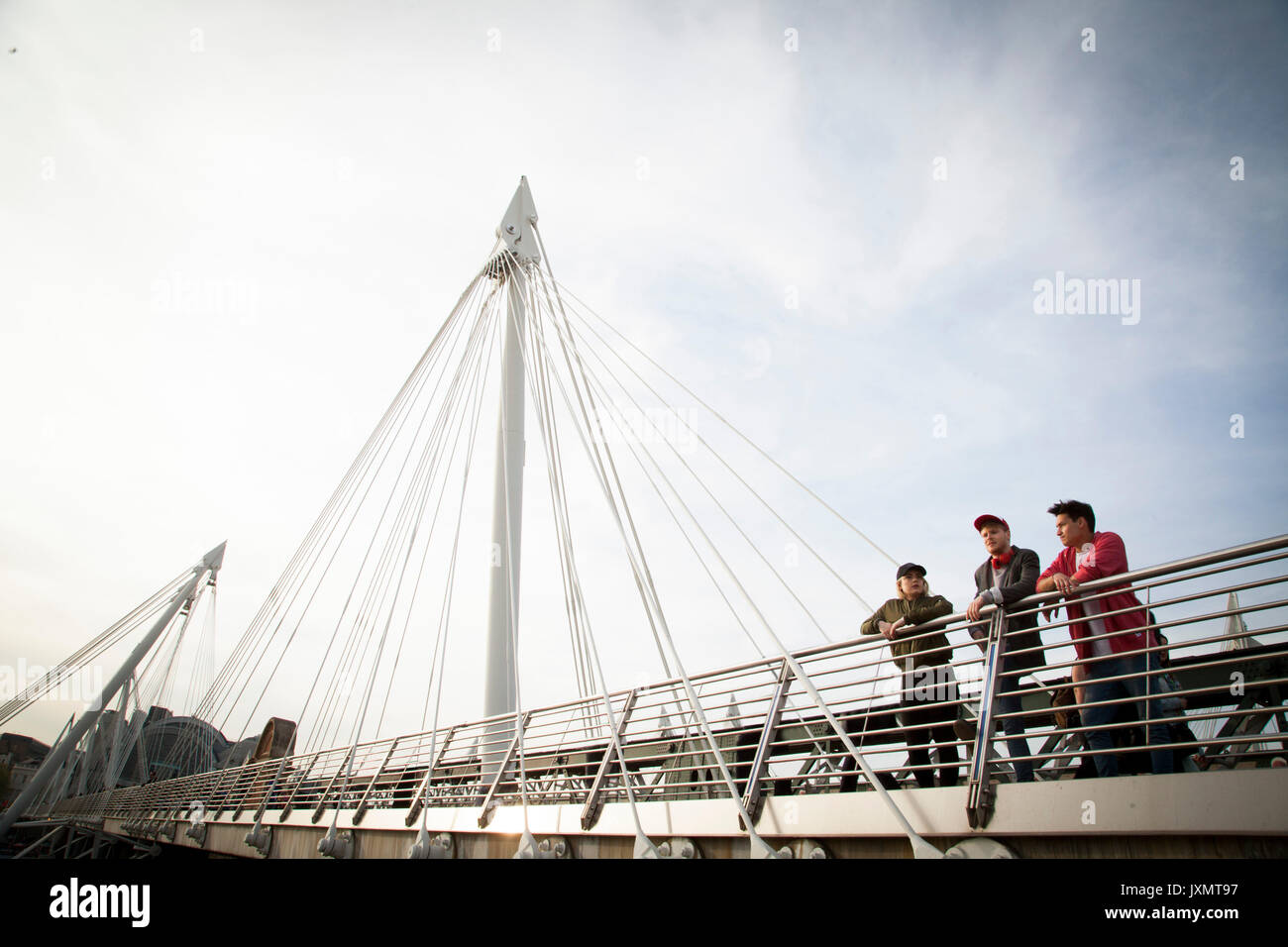 Three friends, standing on bridge, looking at view, Golden Jubilee ...