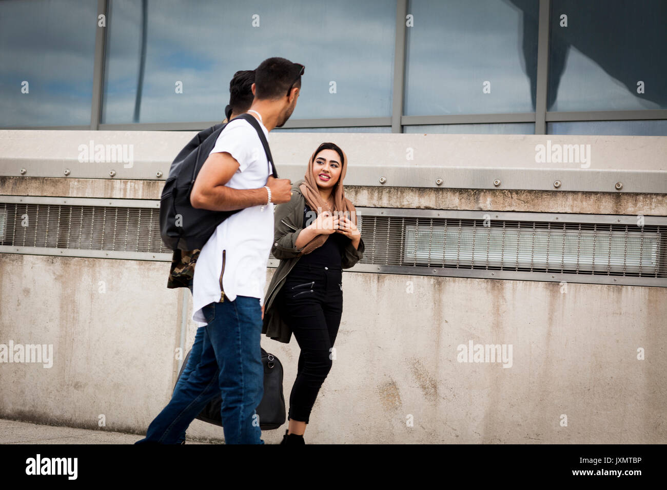 Three friends, walking in street together Stock Photo - Alamy