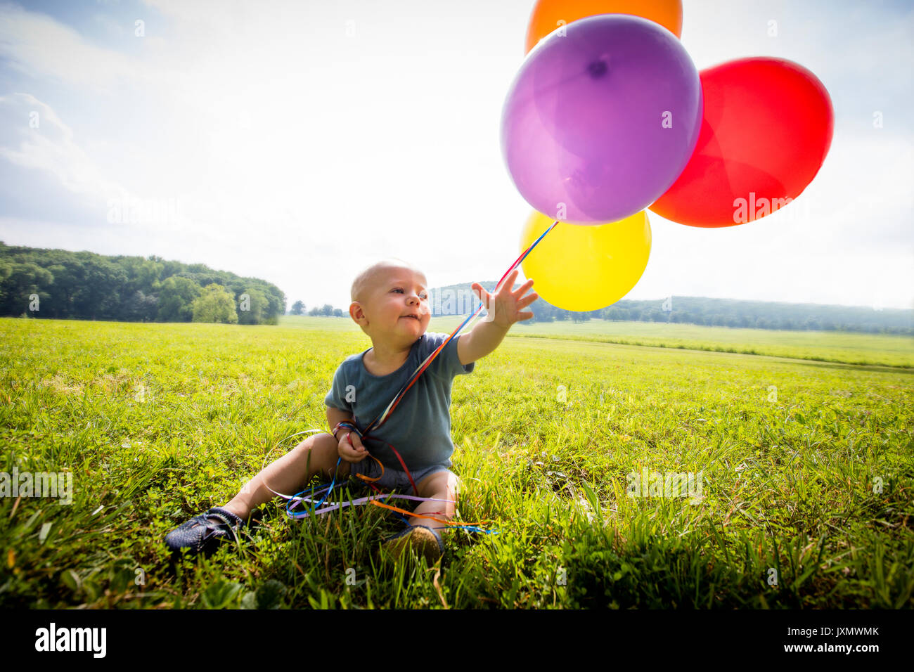 Boy floating with balloons hi-res stock photography and images - Alamy