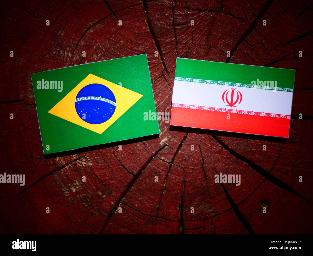 Brazilian flag with Iranian flag on a tree stump isolated Stock Photo ...