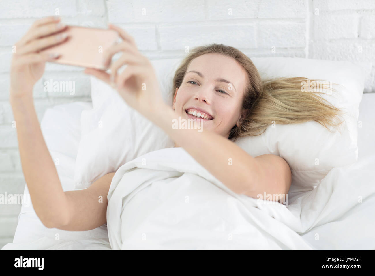 Woman Lying On Bed Taking Selfie Hi Res Stock Photography And Images