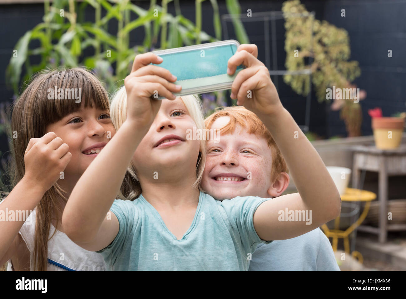 Smiling children taking selfie Stock Photo - Alamy