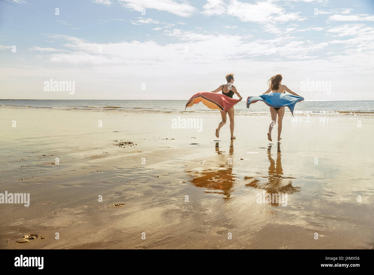Mother And Daughter Running On Beach With Shawls In Air Folkestone Uk