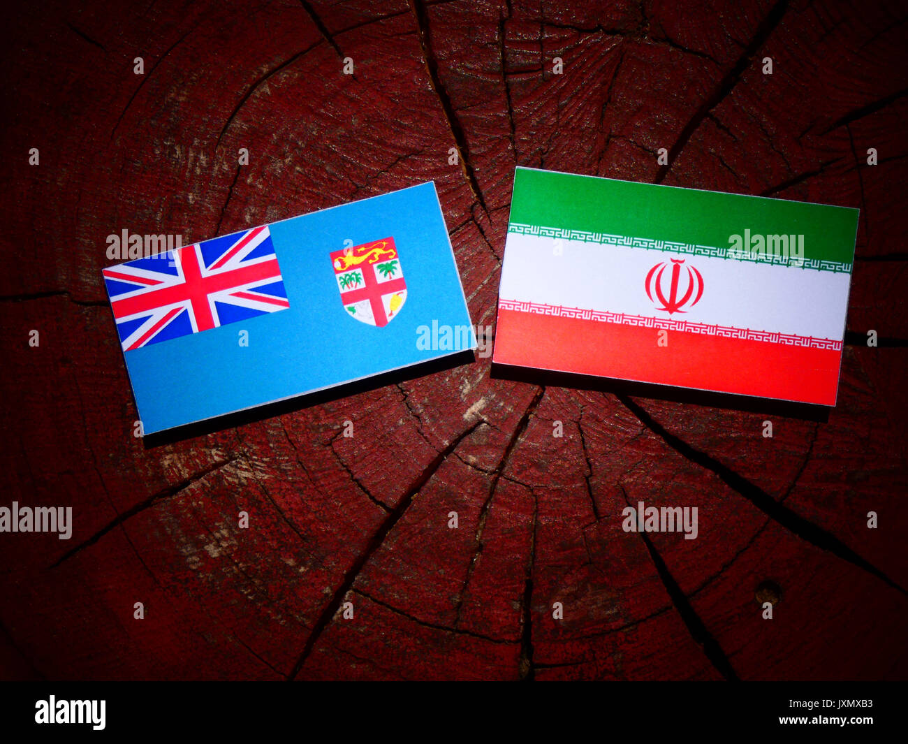 Fijian flag with Iranian flag on a tree stump isolated Stock Photo - Alamy