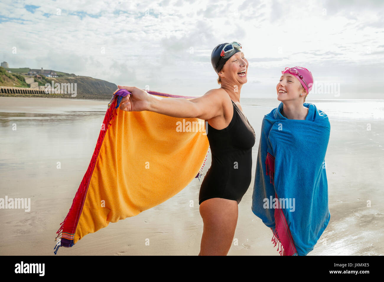 Mother And Daughter Standing On Beach With Shawls Folkestone Uk Stock