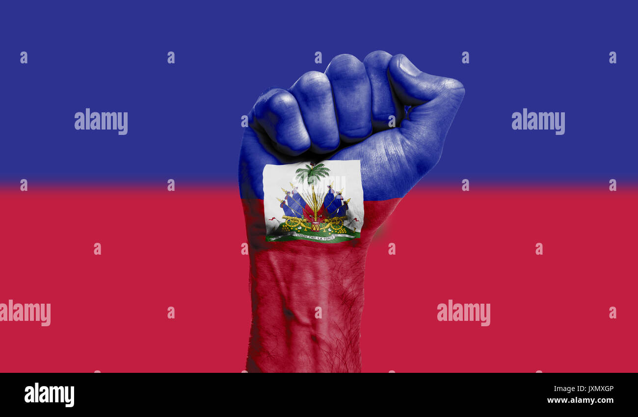 Haiti flag painted on a clenched fist. Strength, Power, Protest concept ...