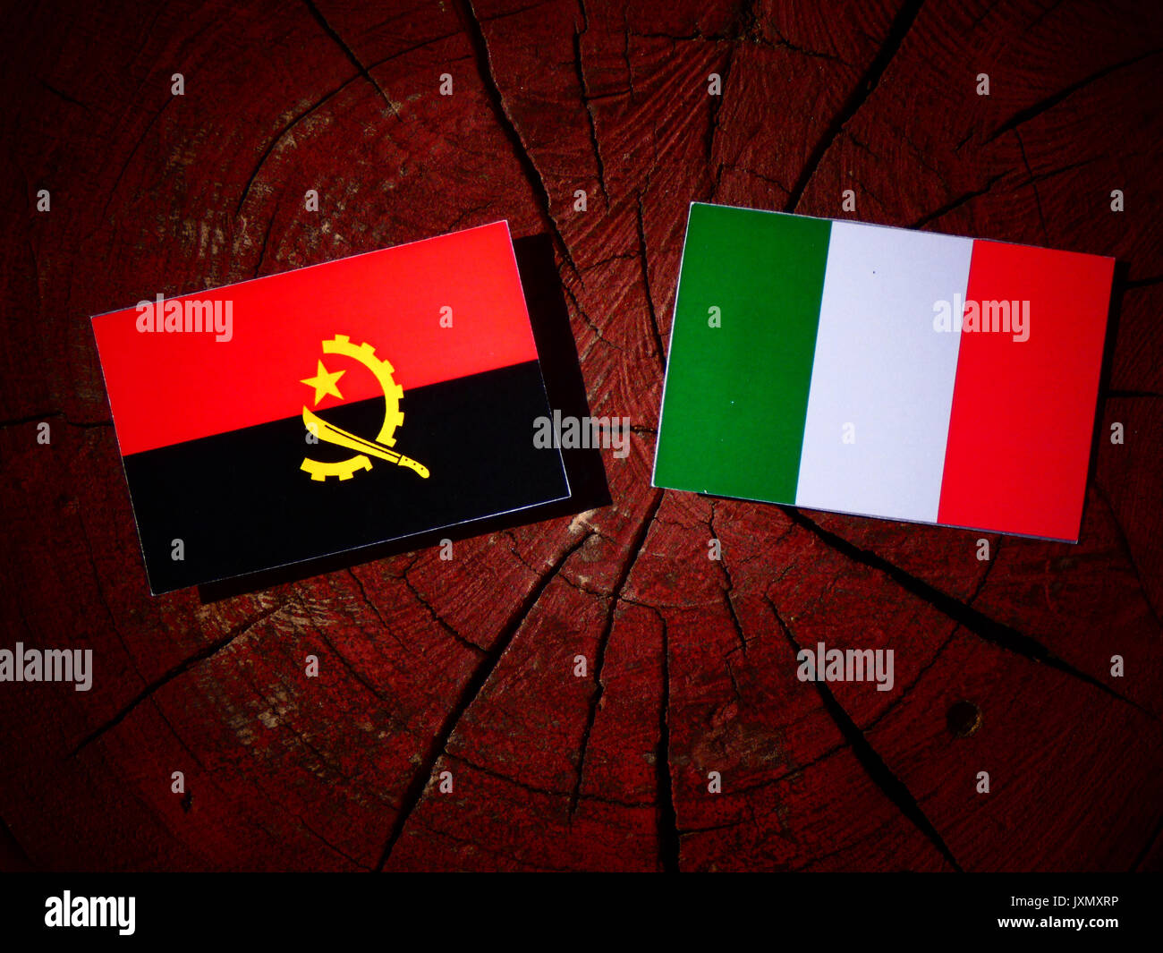 Angolan flag with Italian flag on a tree stump isolated Stock Photo - Alamy