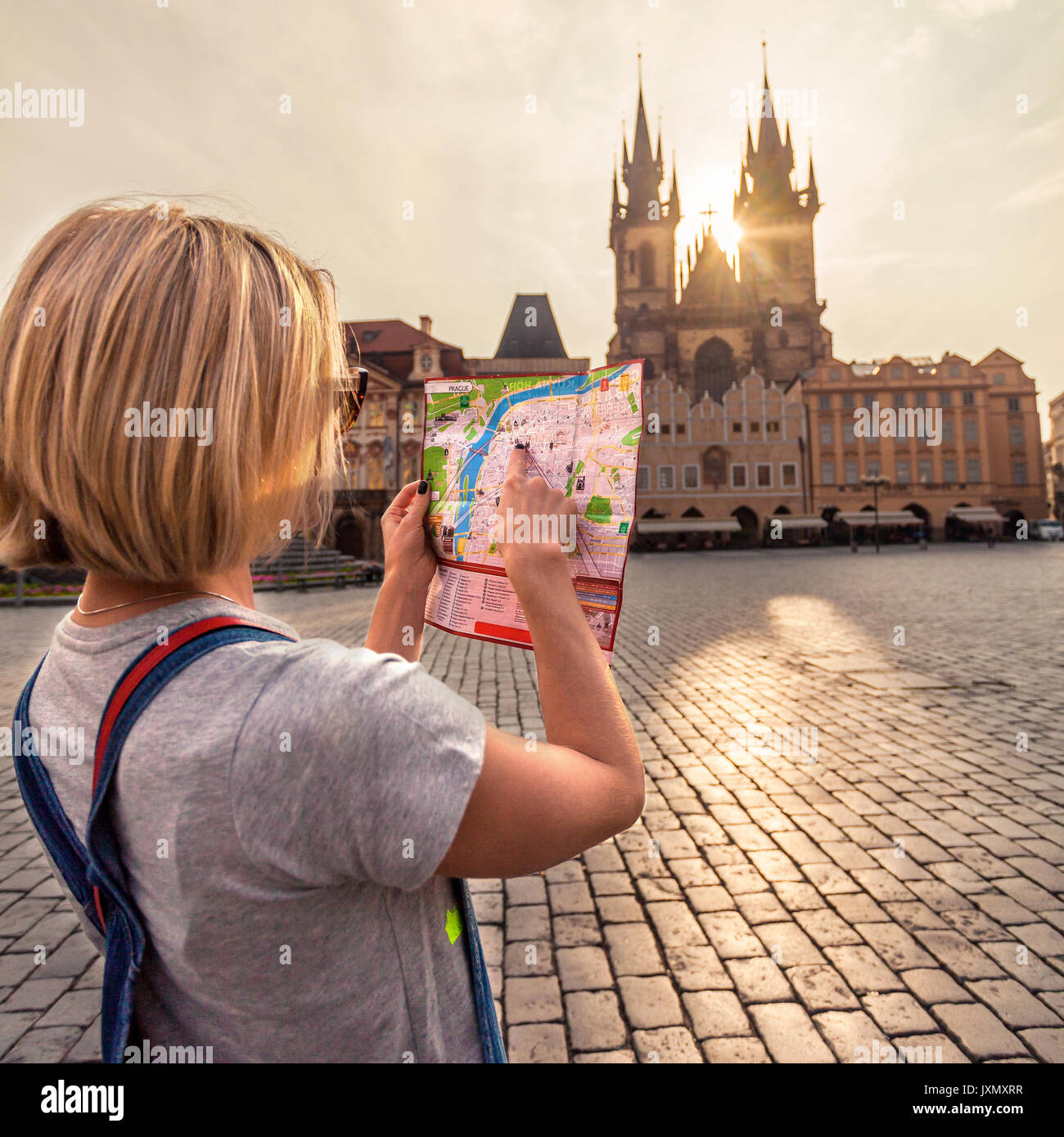 Beautiful young girl in Prague looks at the city map Stock Photo - Alamy