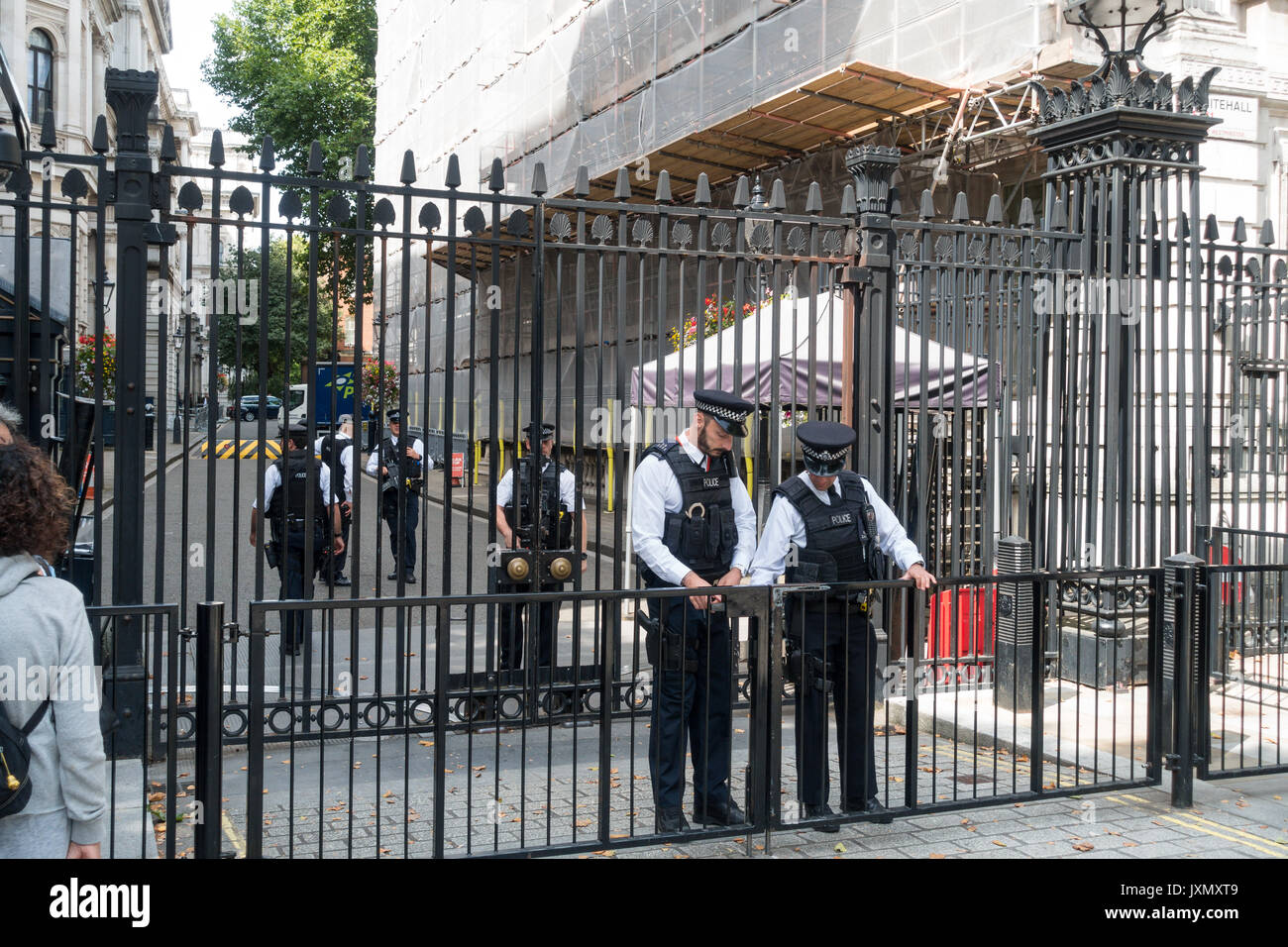 Armed Police and security gates guard the entrance to Downing St ...