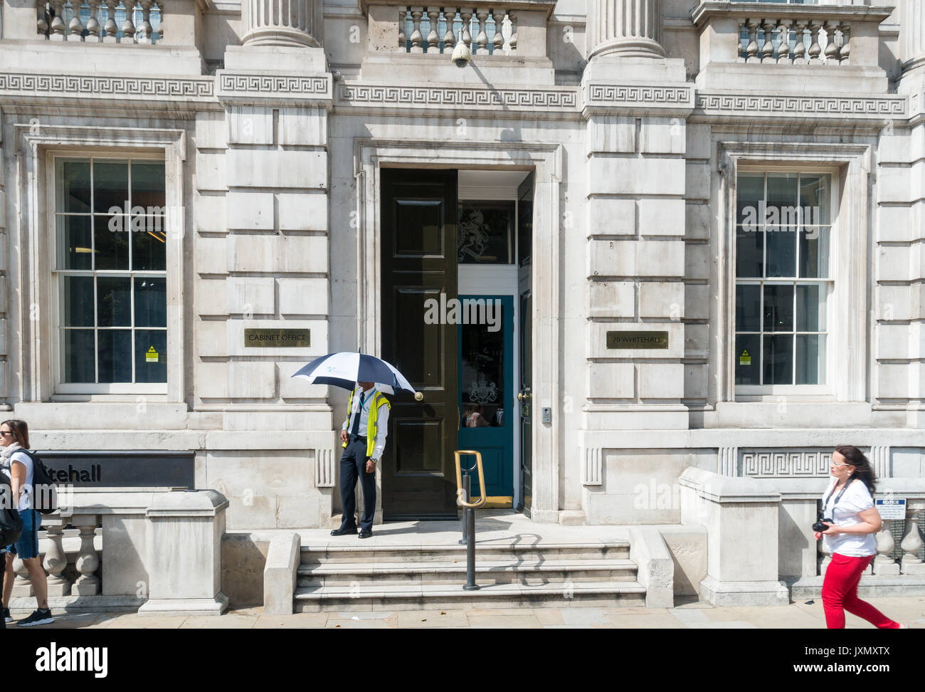 Security man with umbrella on the steps of the Cabinet Office, 70 ...