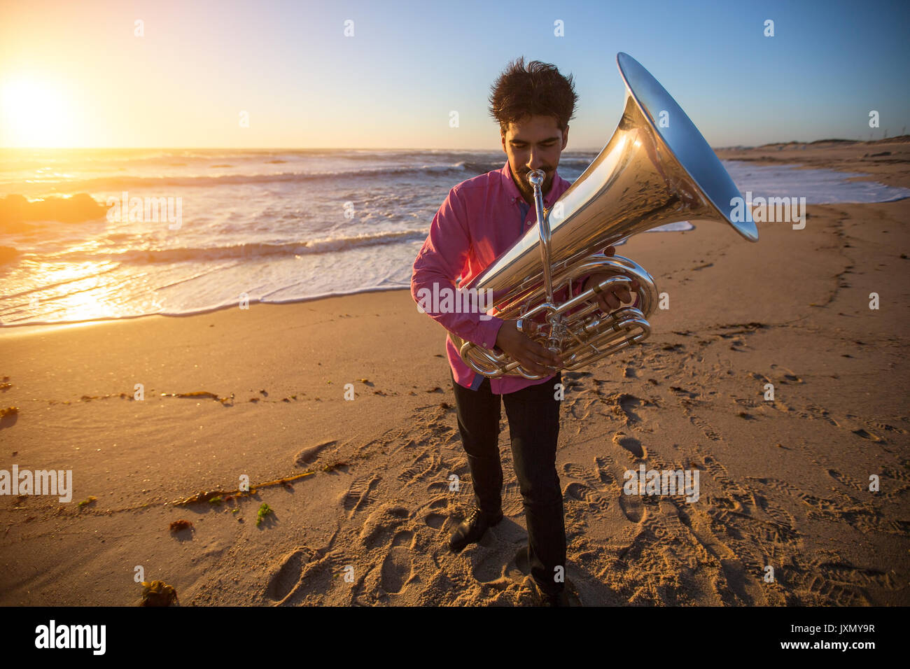 Musician play to musical instrument Tuba on ocean shore Stock Photo - Alamy