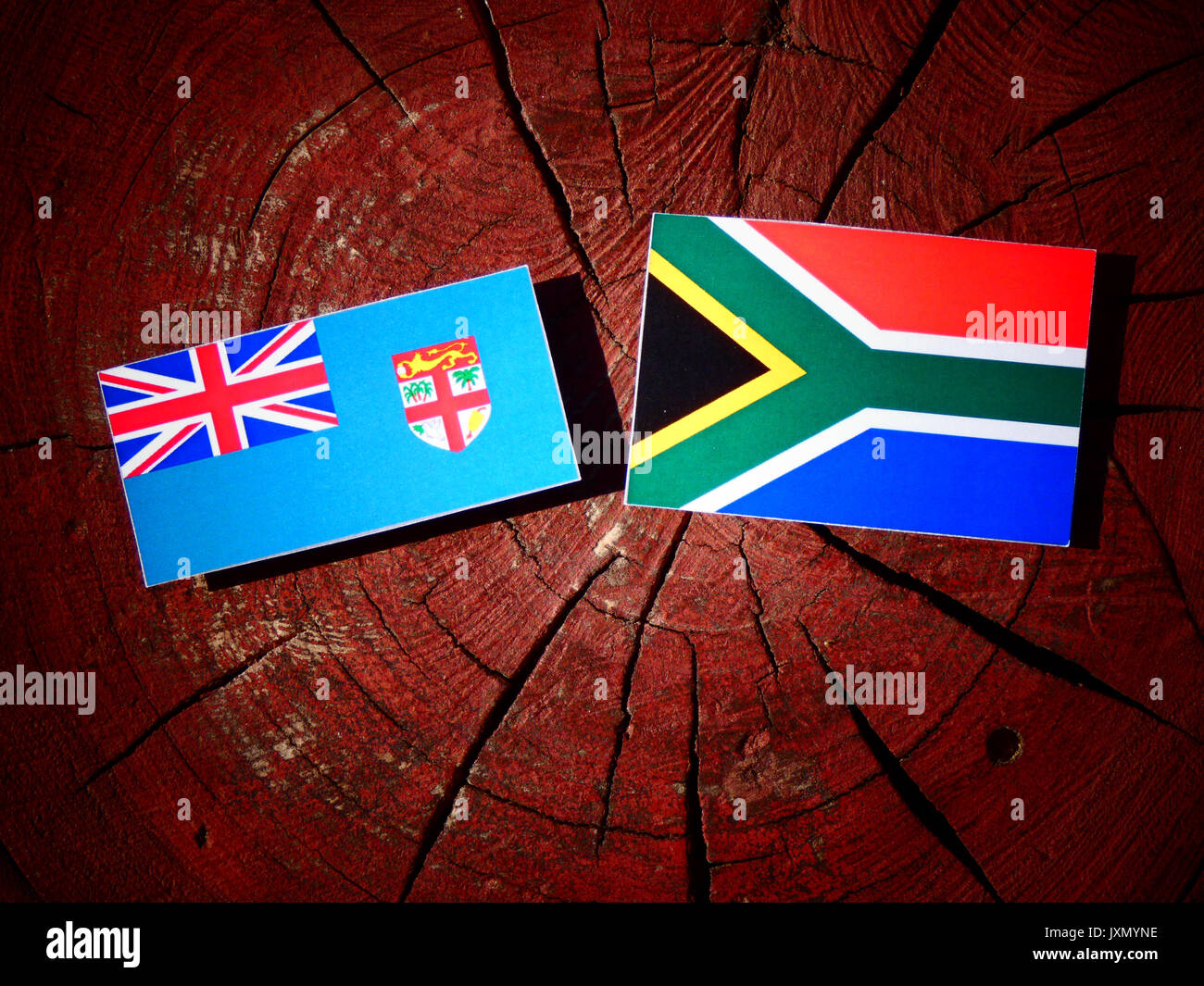 Fijian flag with South African flag on a tree stump isolated Stock ...