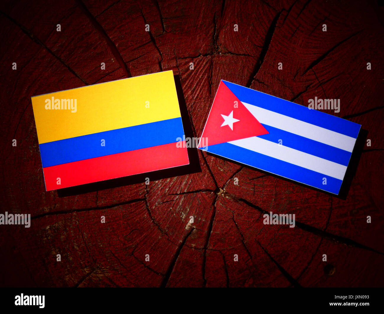 Colombian flag with Cuban flag on a tree stump isolated Stock Photo - Alamy