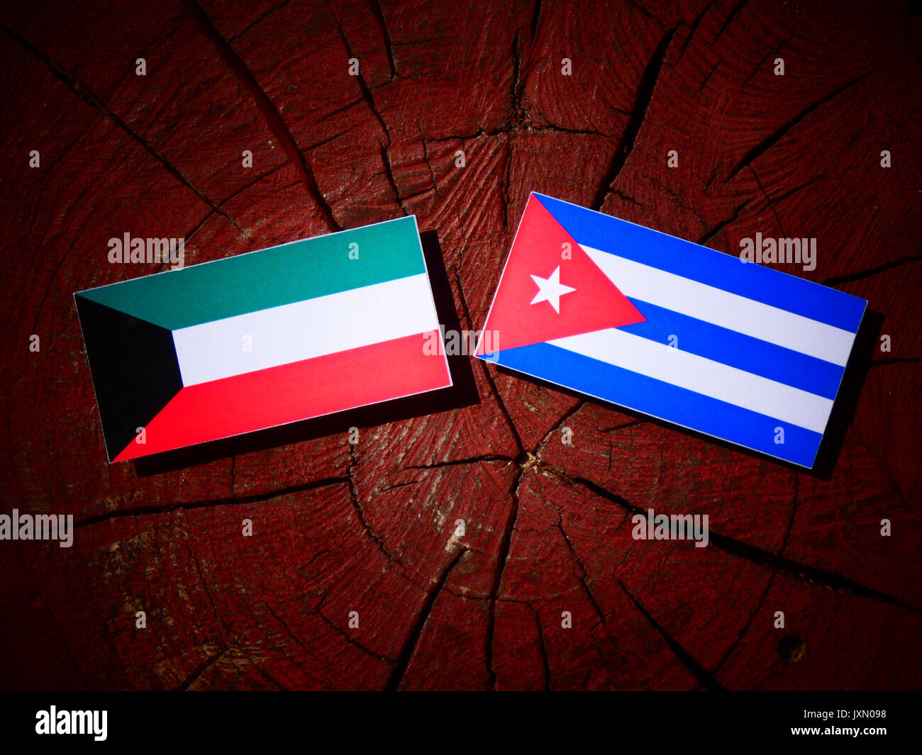 Kuwaiti flag with Cuban flag on a tree stump isolated Stock Photo - Alamy