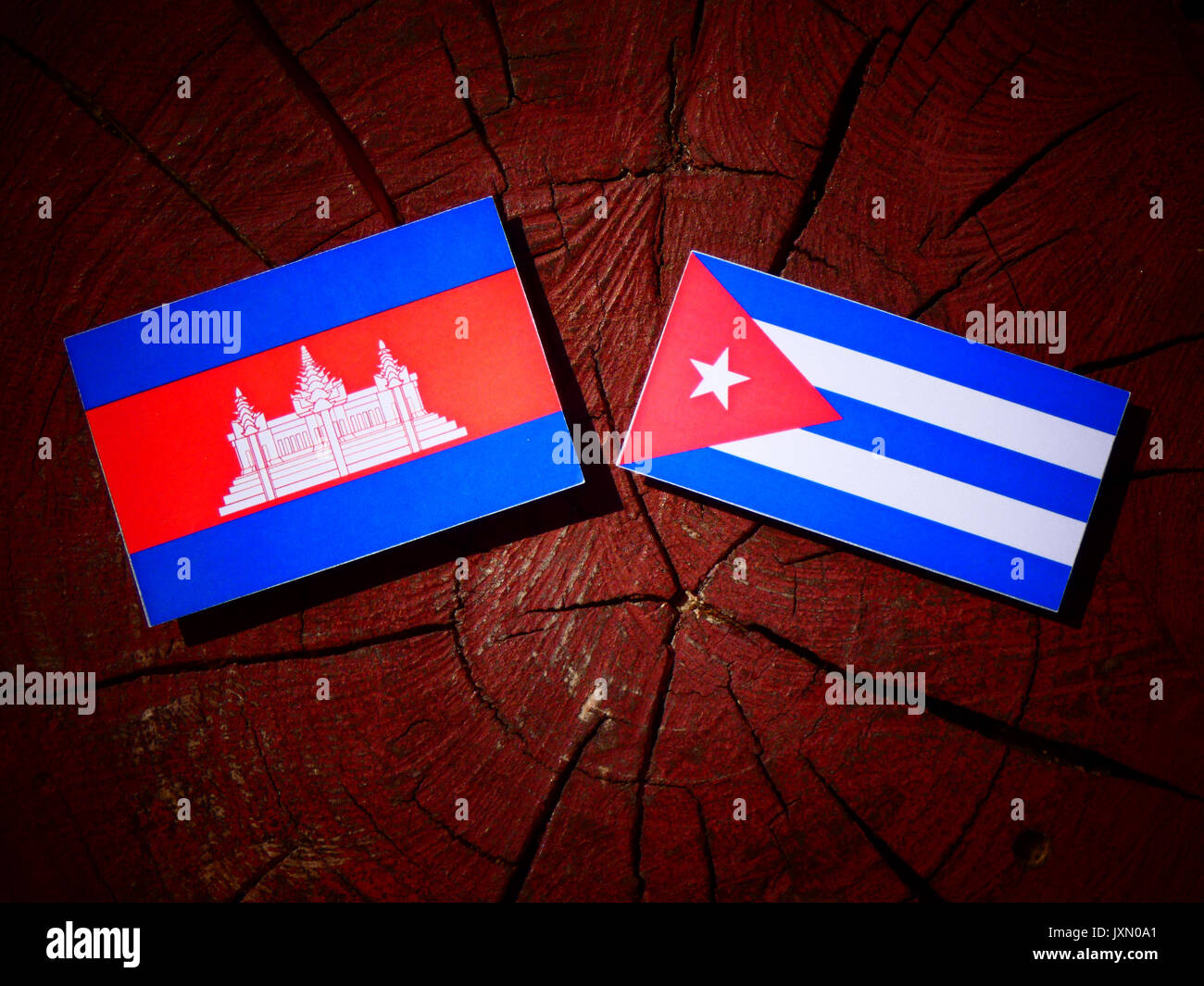 Cambodian flag with Cuban flag on a tree stump isolated Stock Photo - Alamy