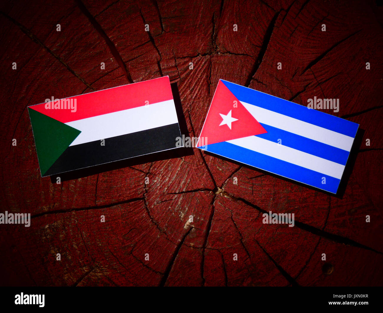 Sudan flag with Cuban flag on a tree stump isolated Stock Photo - Alamy