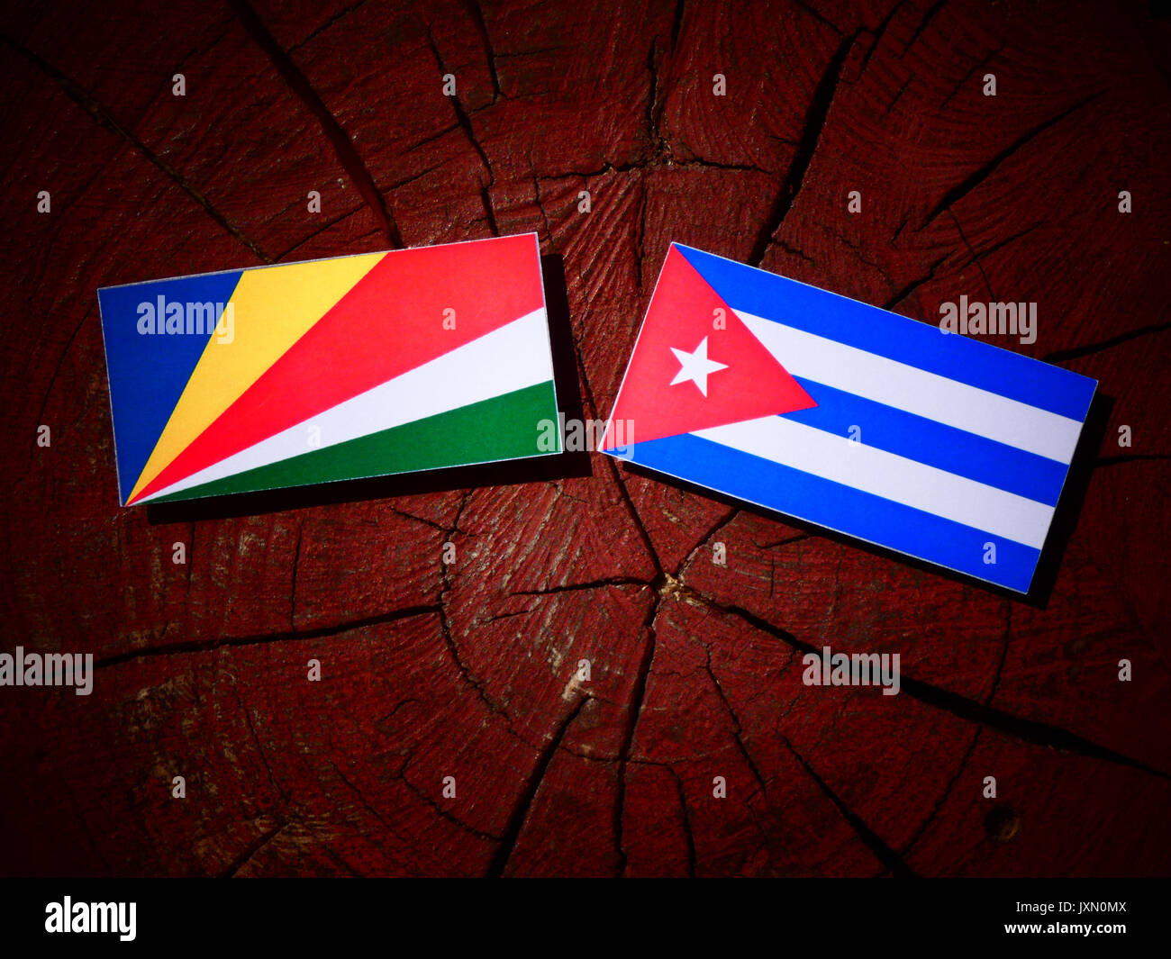 Seychelles flag with Cuban flag on a tree stump isolated Stock Photo ...