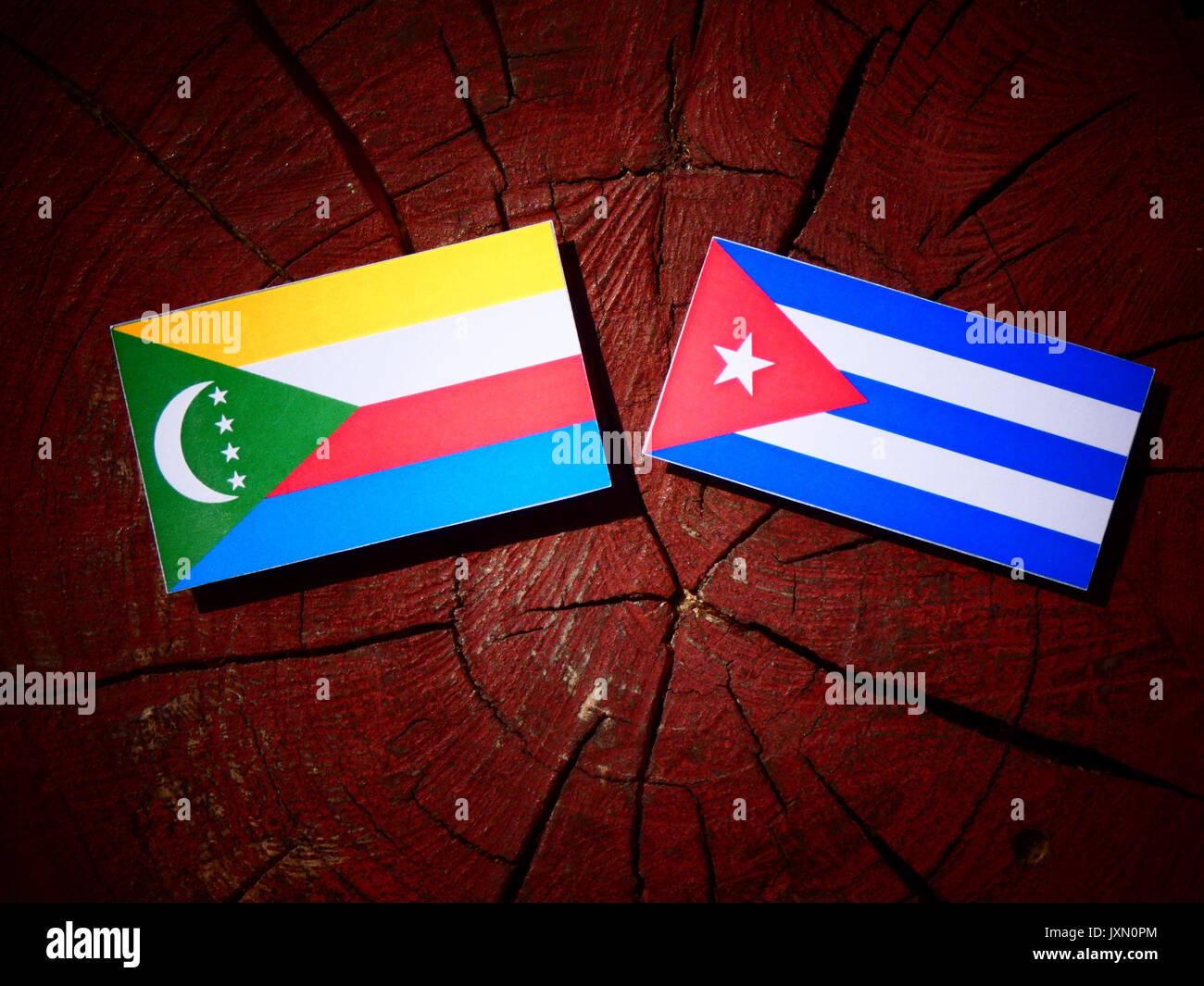 Comoros flag with Cuban flag on a tree stump isolated Stock Photo - Alamy