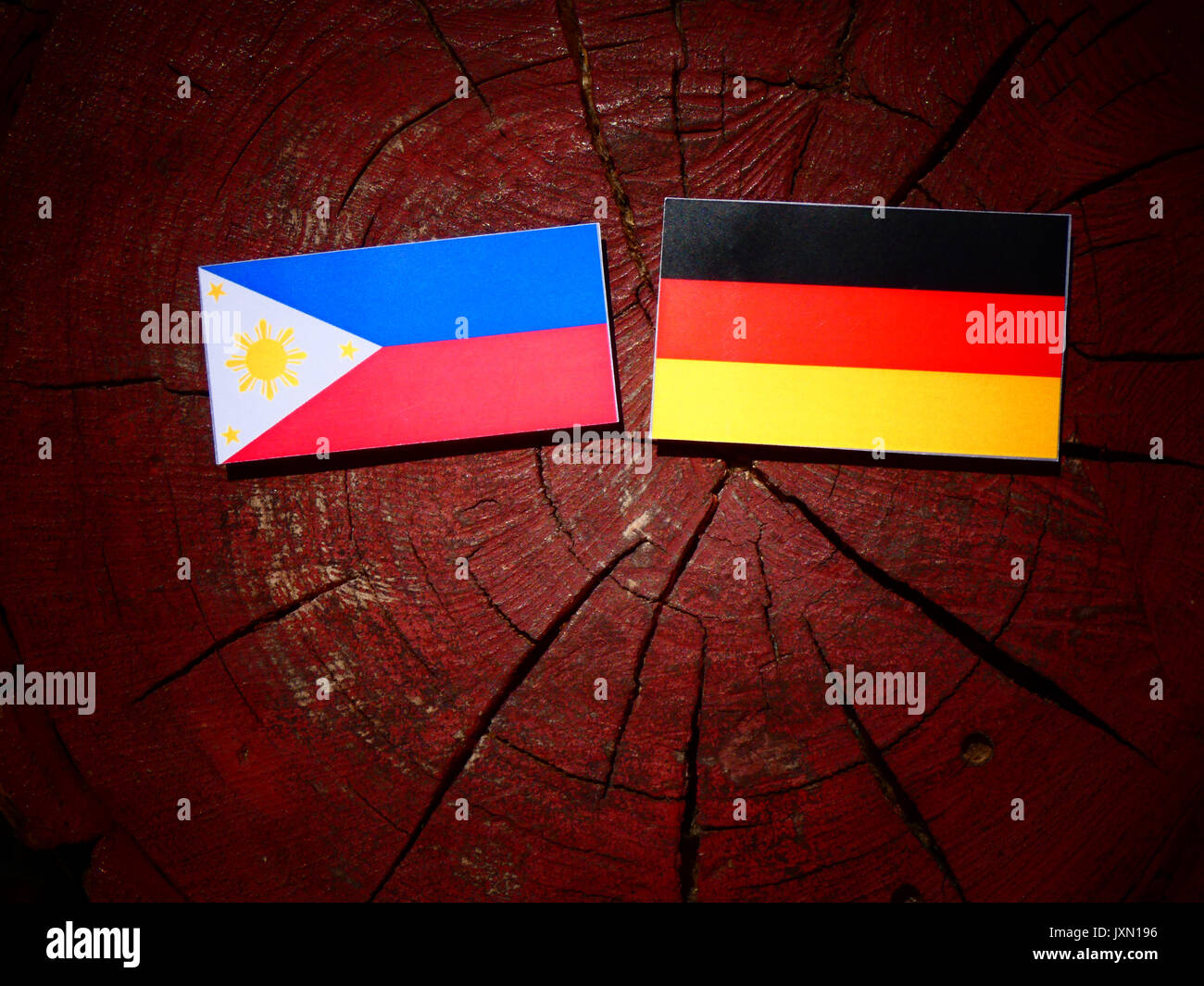 Philippines flag with German flag on a tree stump isolated Stock Photo ...